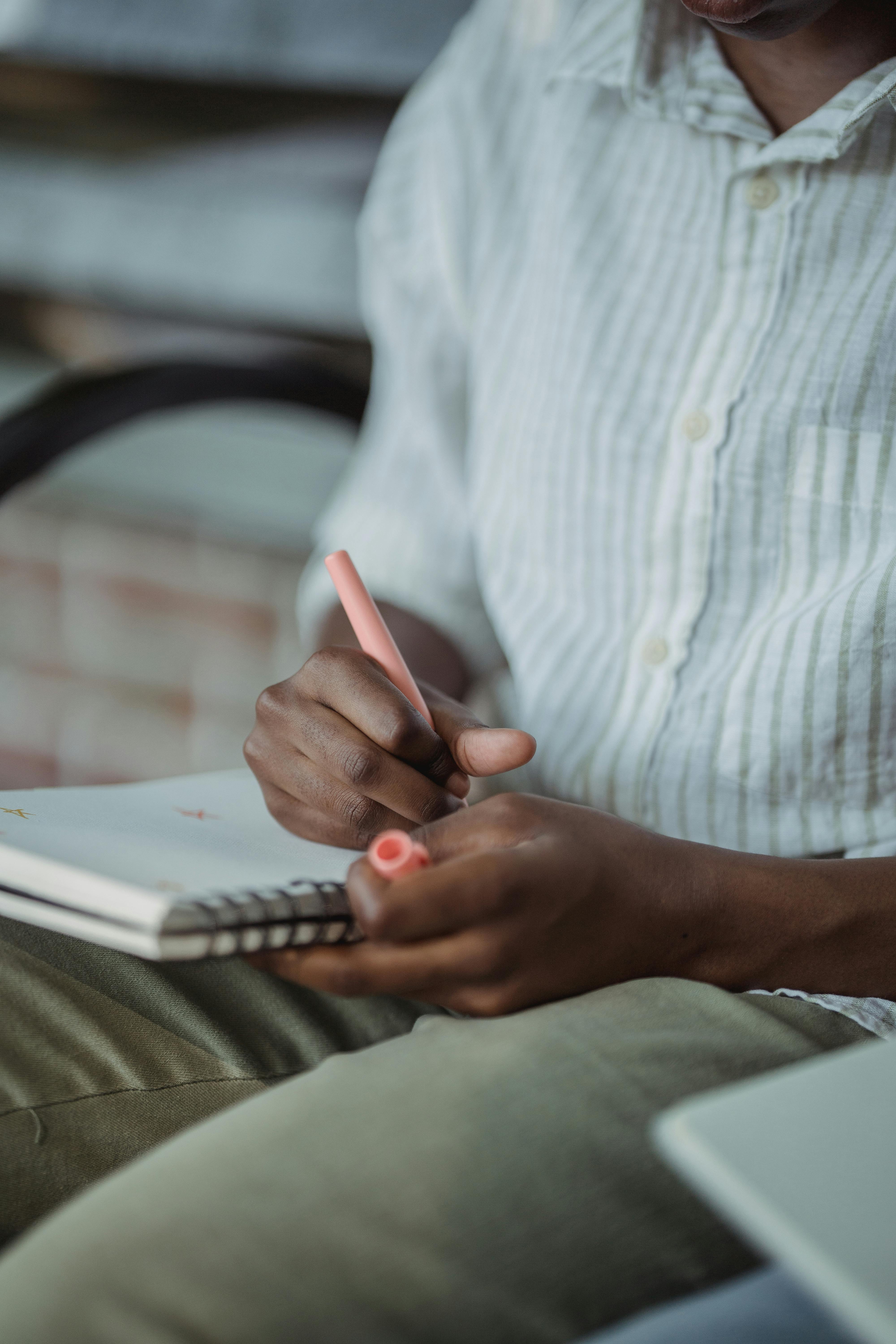 Close-up of Person Writing in Notebook · Free Stock Photo