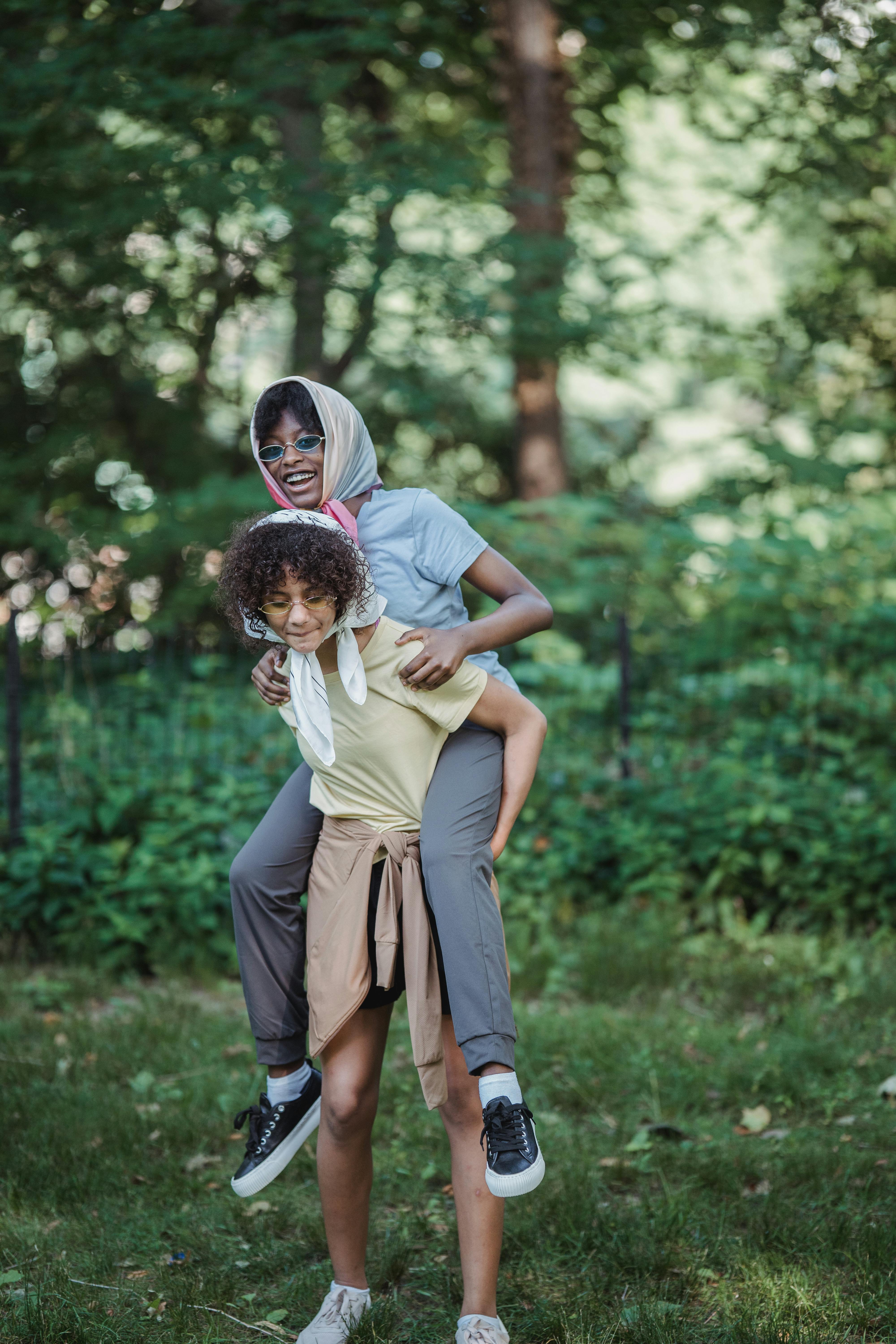 Teenage Girl Carrying her Friend on her Back · Free Stock Photo
