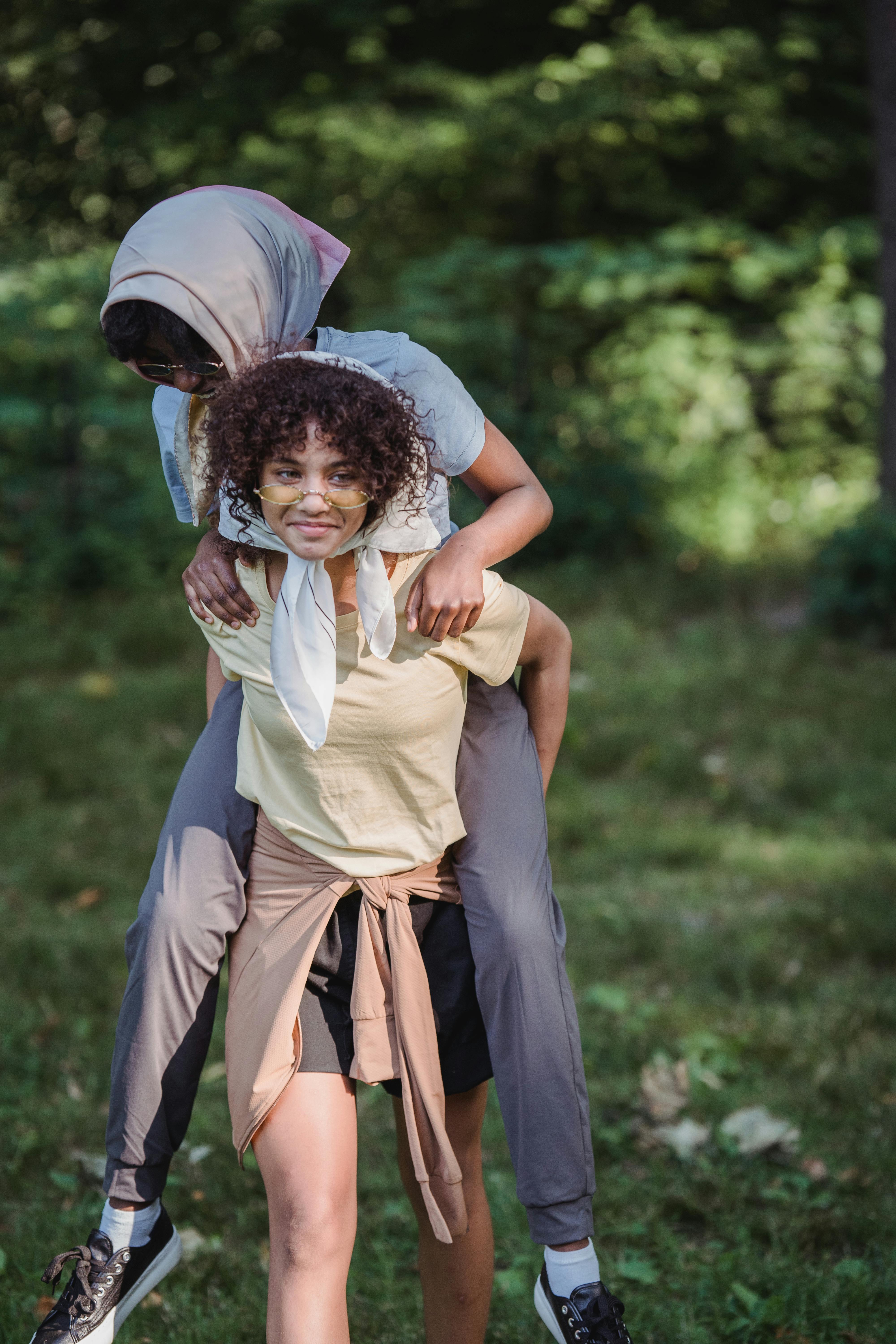 Teenage Girl Carrying her Friend on her Back · Free Stock Photo