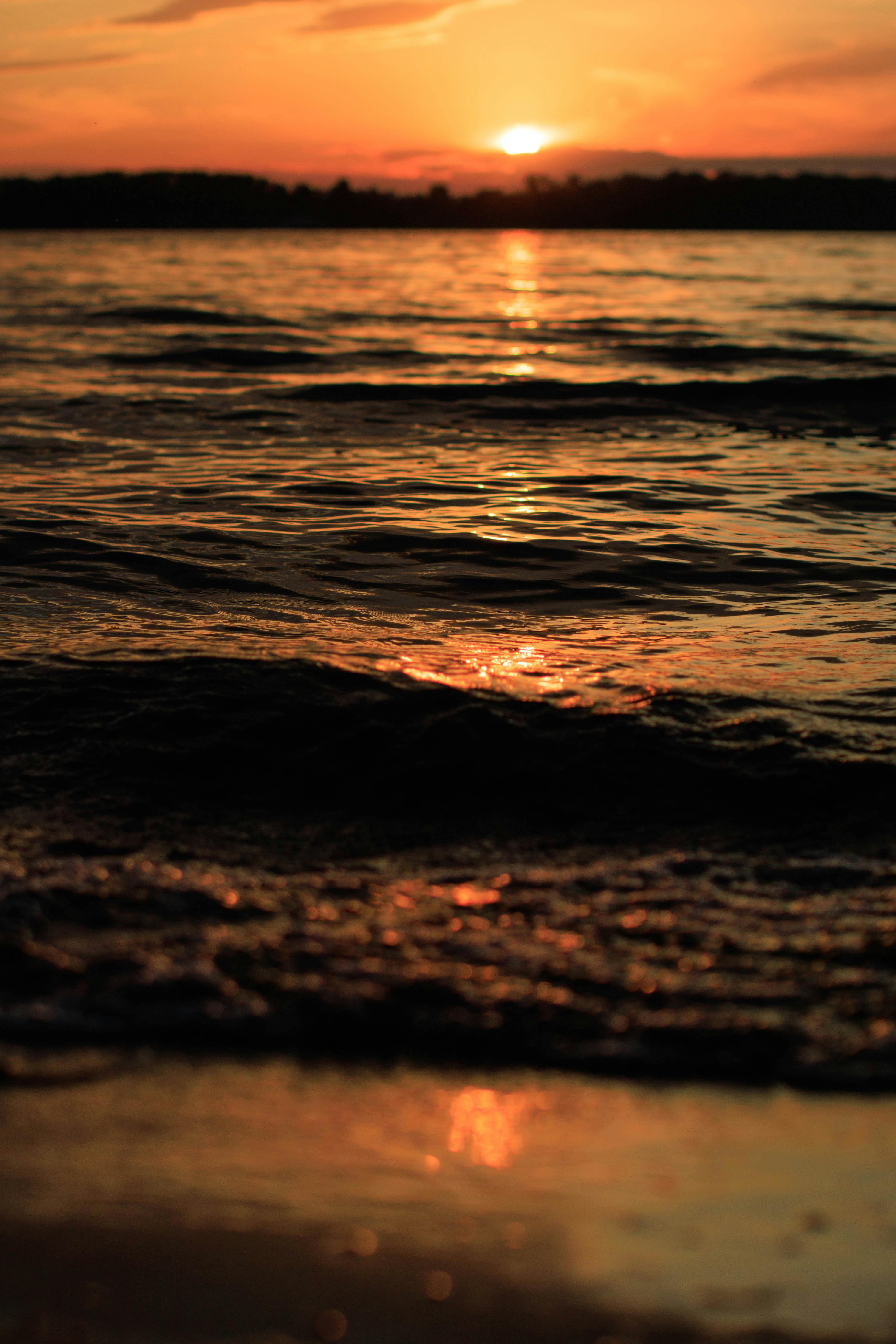 A Sunset Over Body of Water · Free Stock Photo