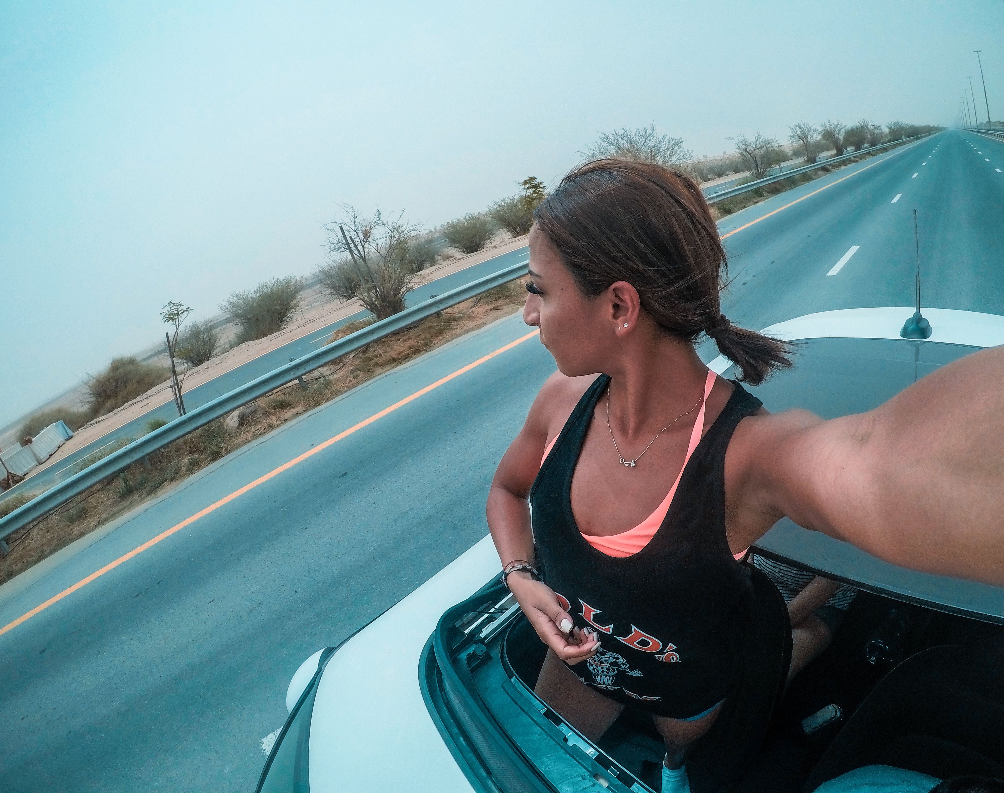 Woman Holding Bicycle on Asphalt Road · Free Stock Photo