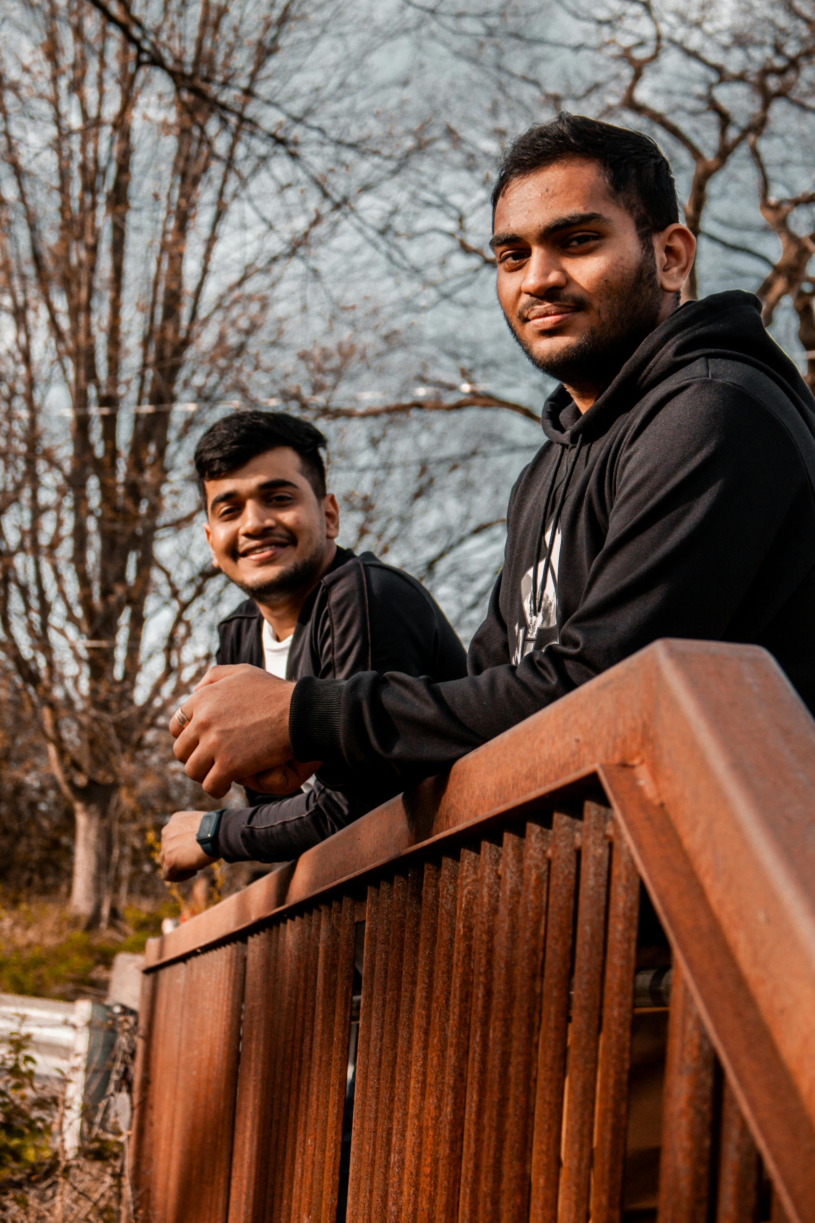 Two Man Standing by a Railing · Free Stock Photo