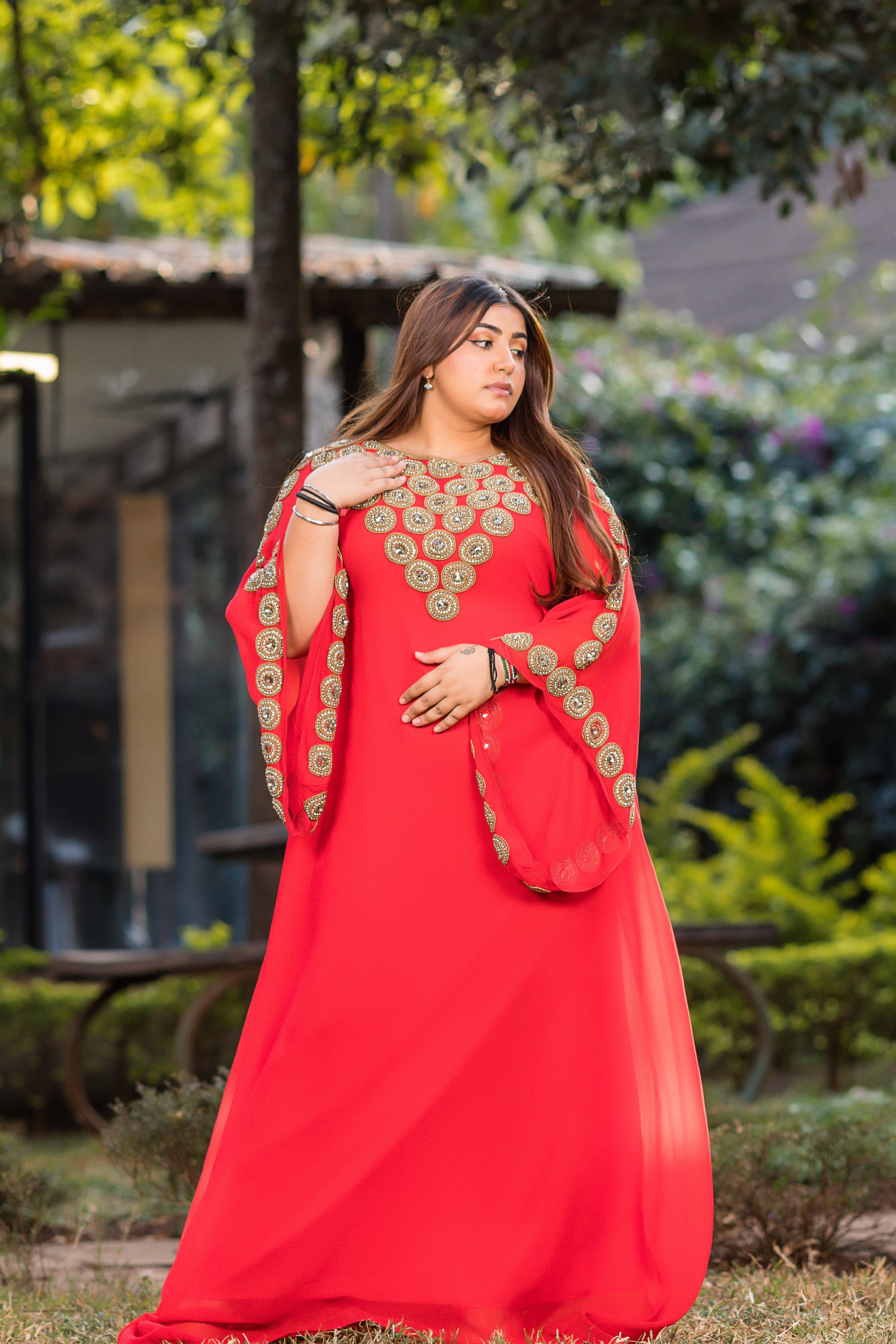 A Portrait of a Woman Wearing a Red Kaftan Dress · Free Stock Photo