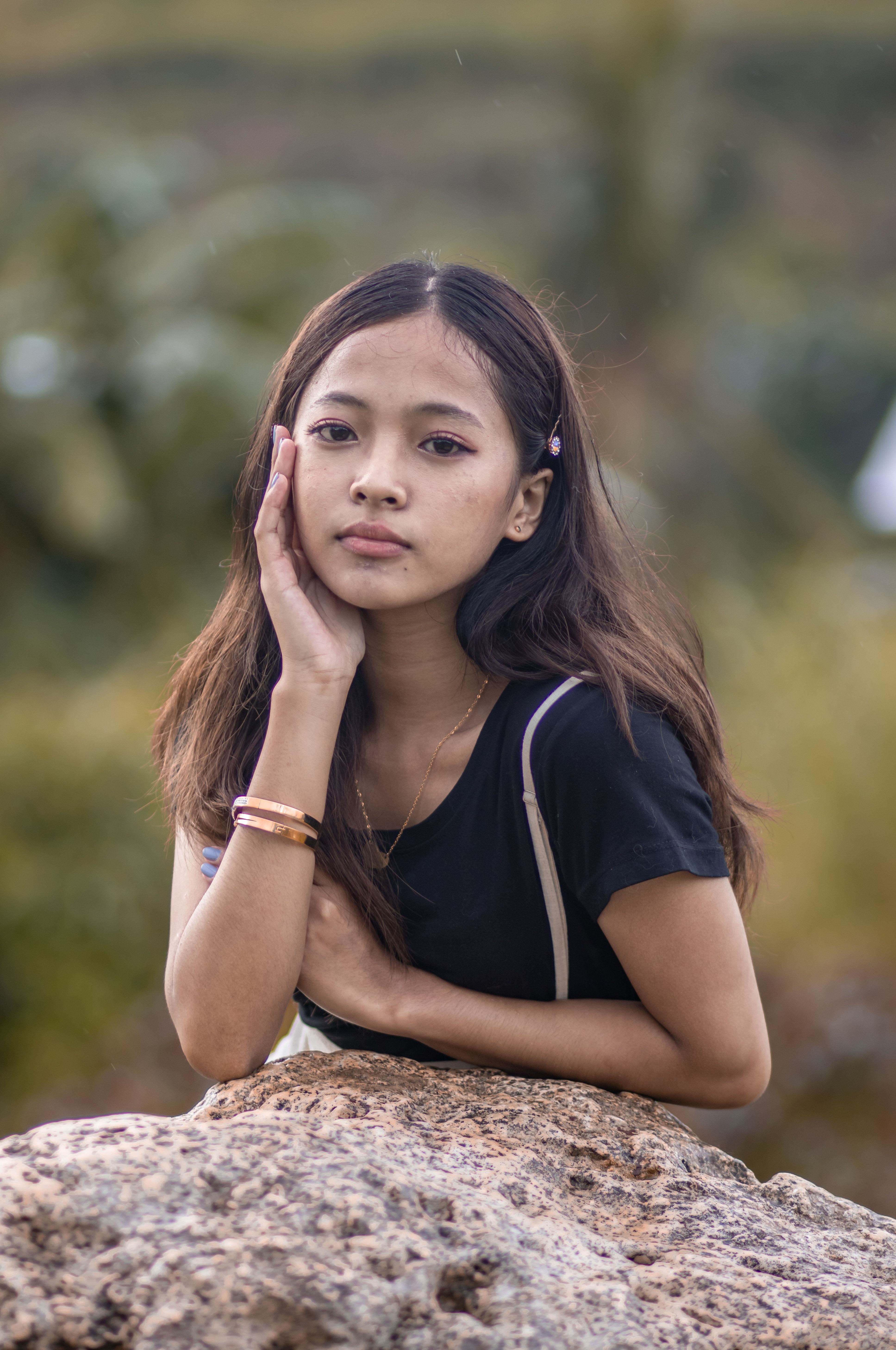 Close-Up Shot of a Girl Leaning on the Rock · Free Stock Photo