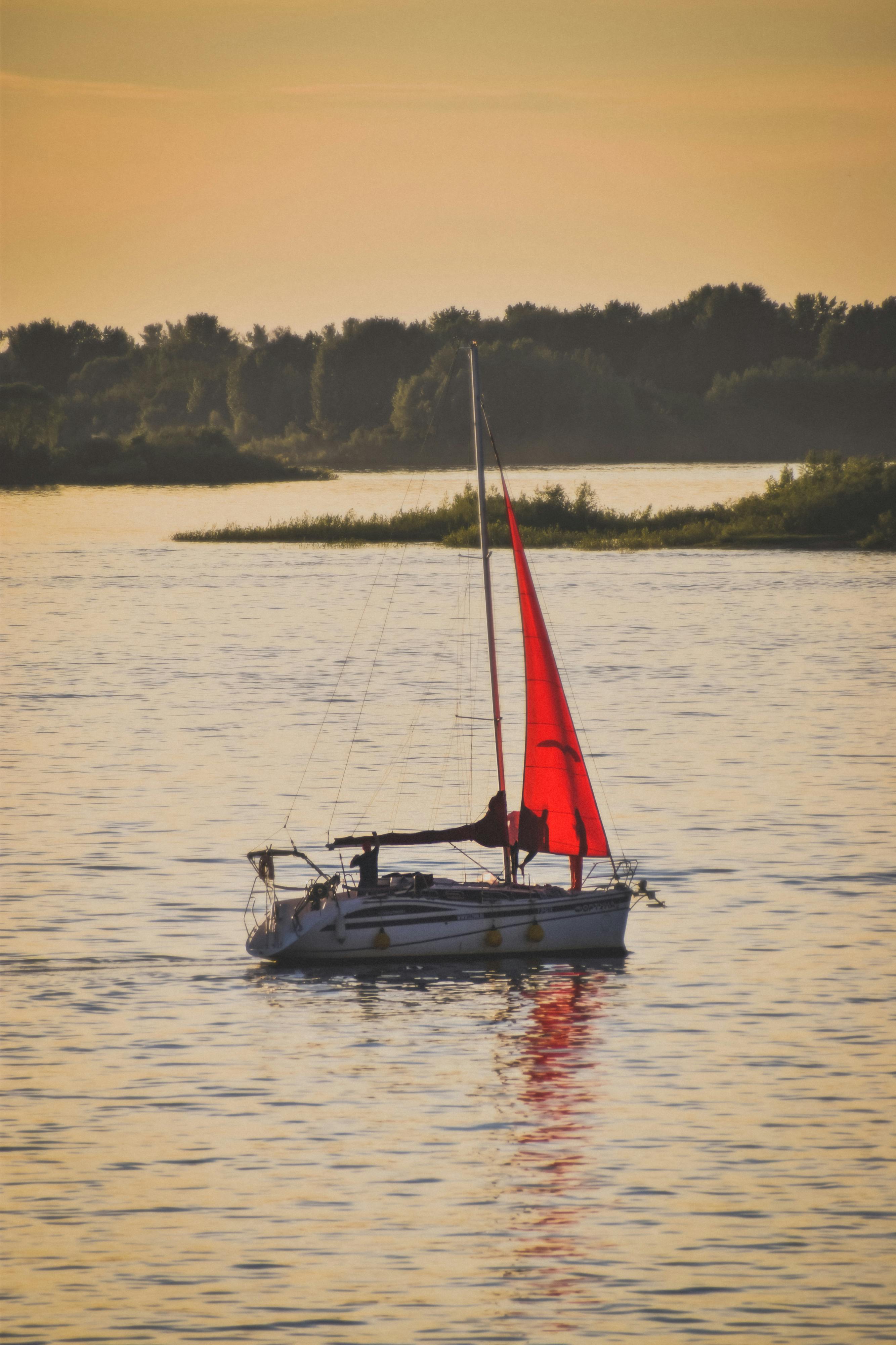 A Sailboat with a Red Sail · Free Stock Photo