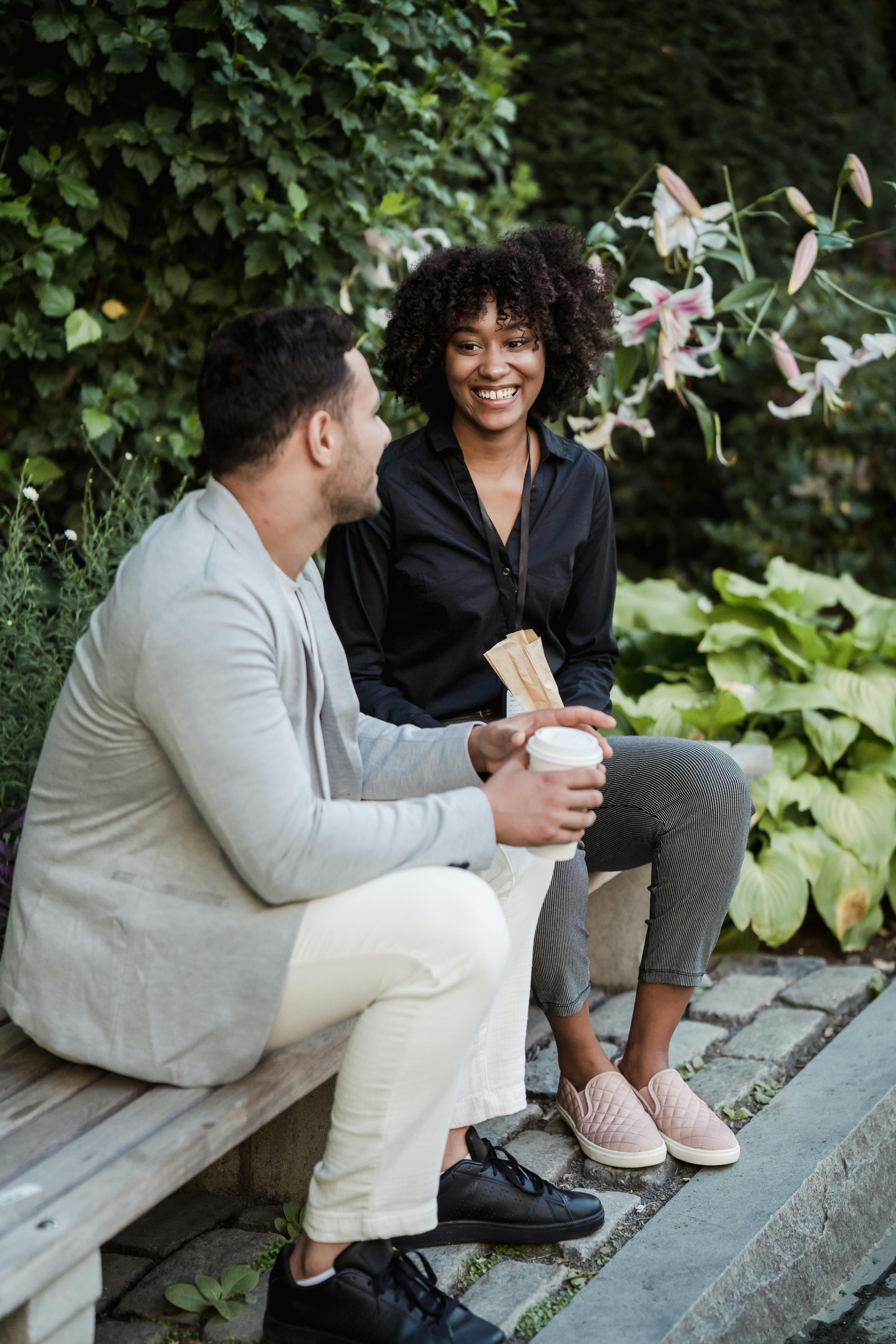 Friends Talking on Bench by Flower · Free Stock Photo