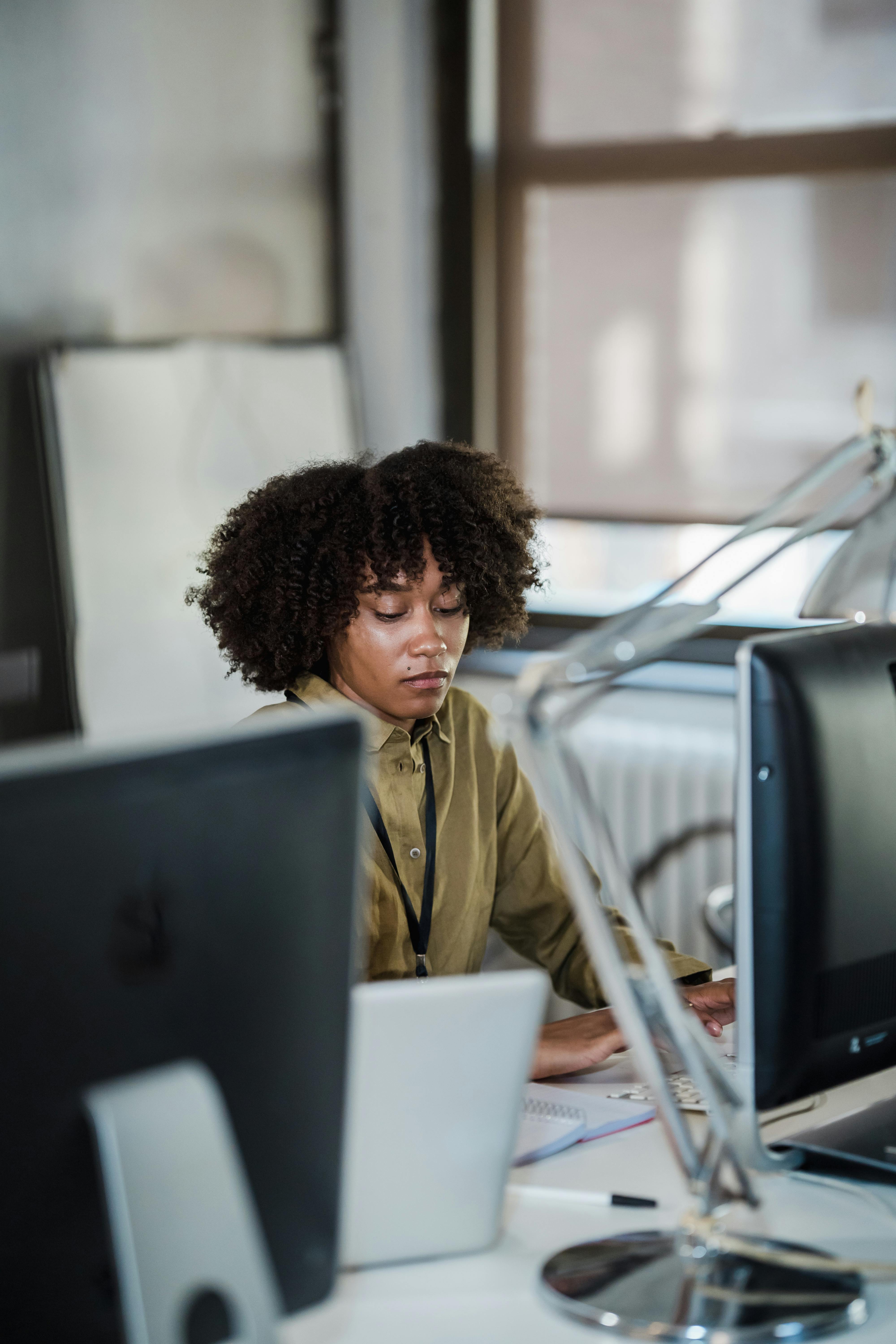 Woman Sorting Documents at Work · Free Stock Photo