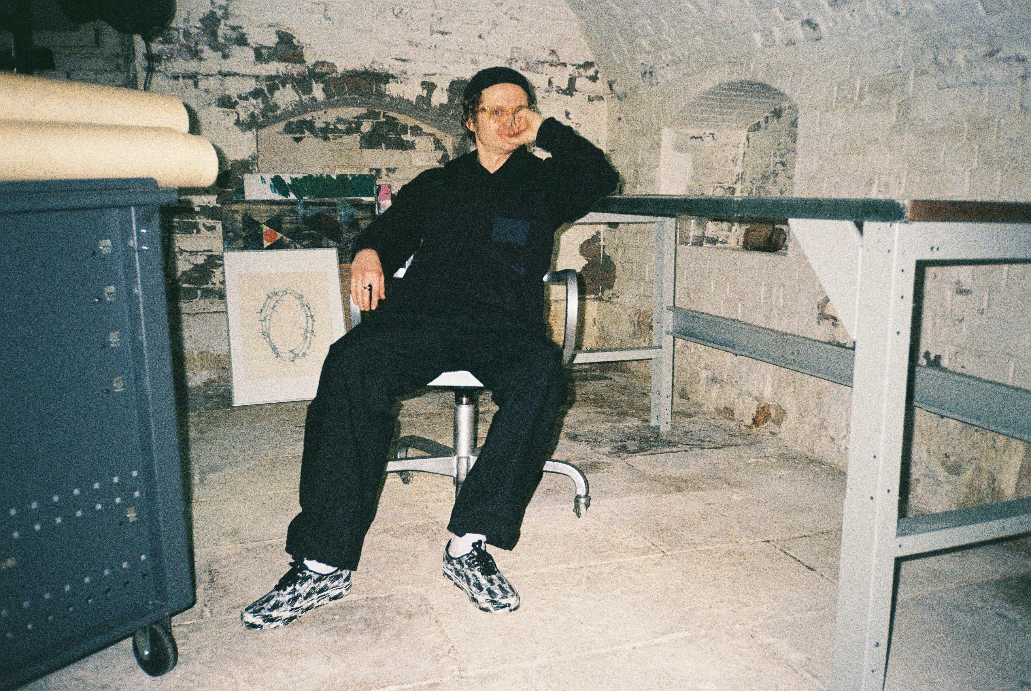 Man in Black Shirt Sitting in Basement · Free Stock Photo
