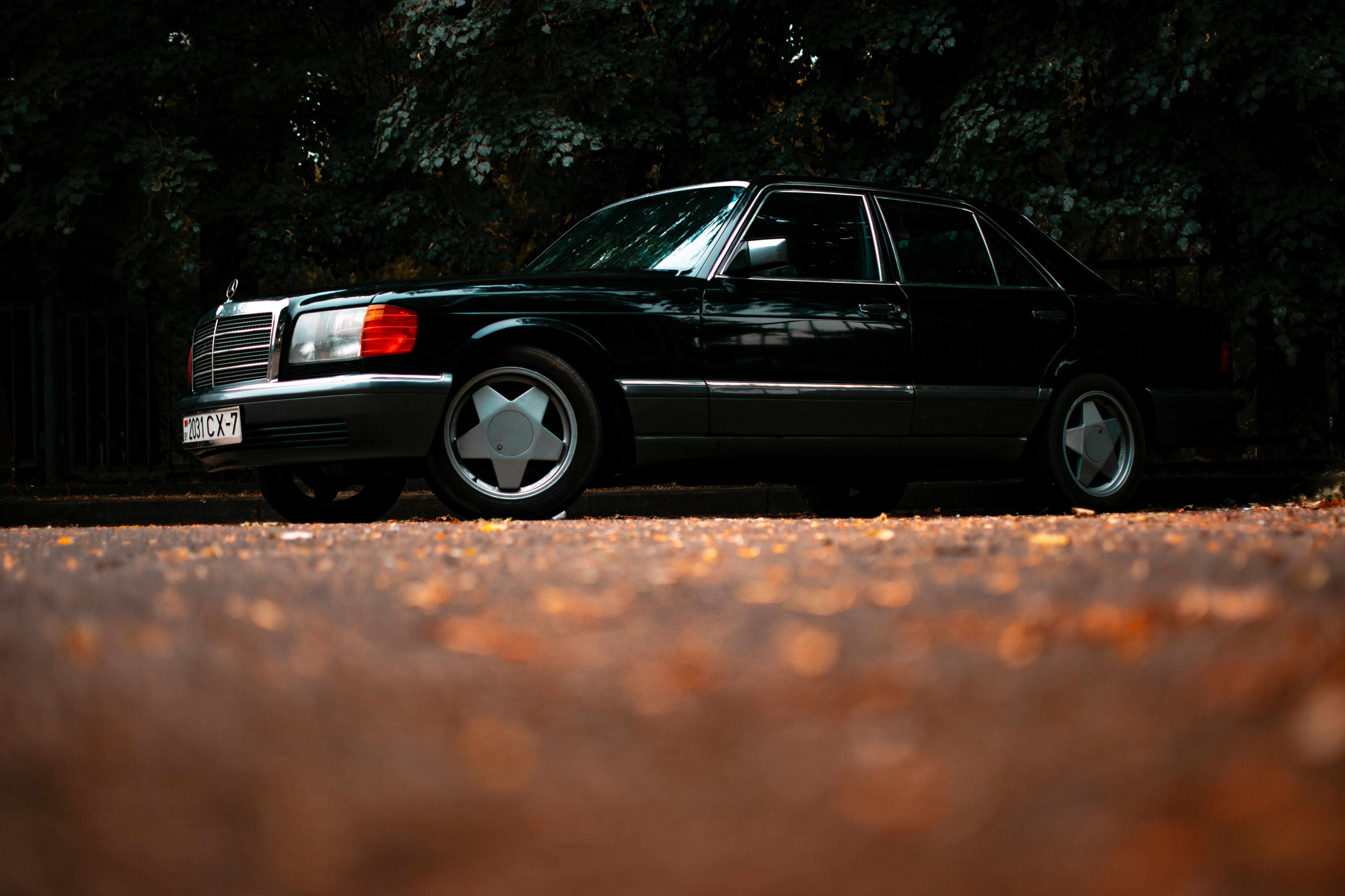 Black Car Parked on Concrete Pavement · Free Stock Photo