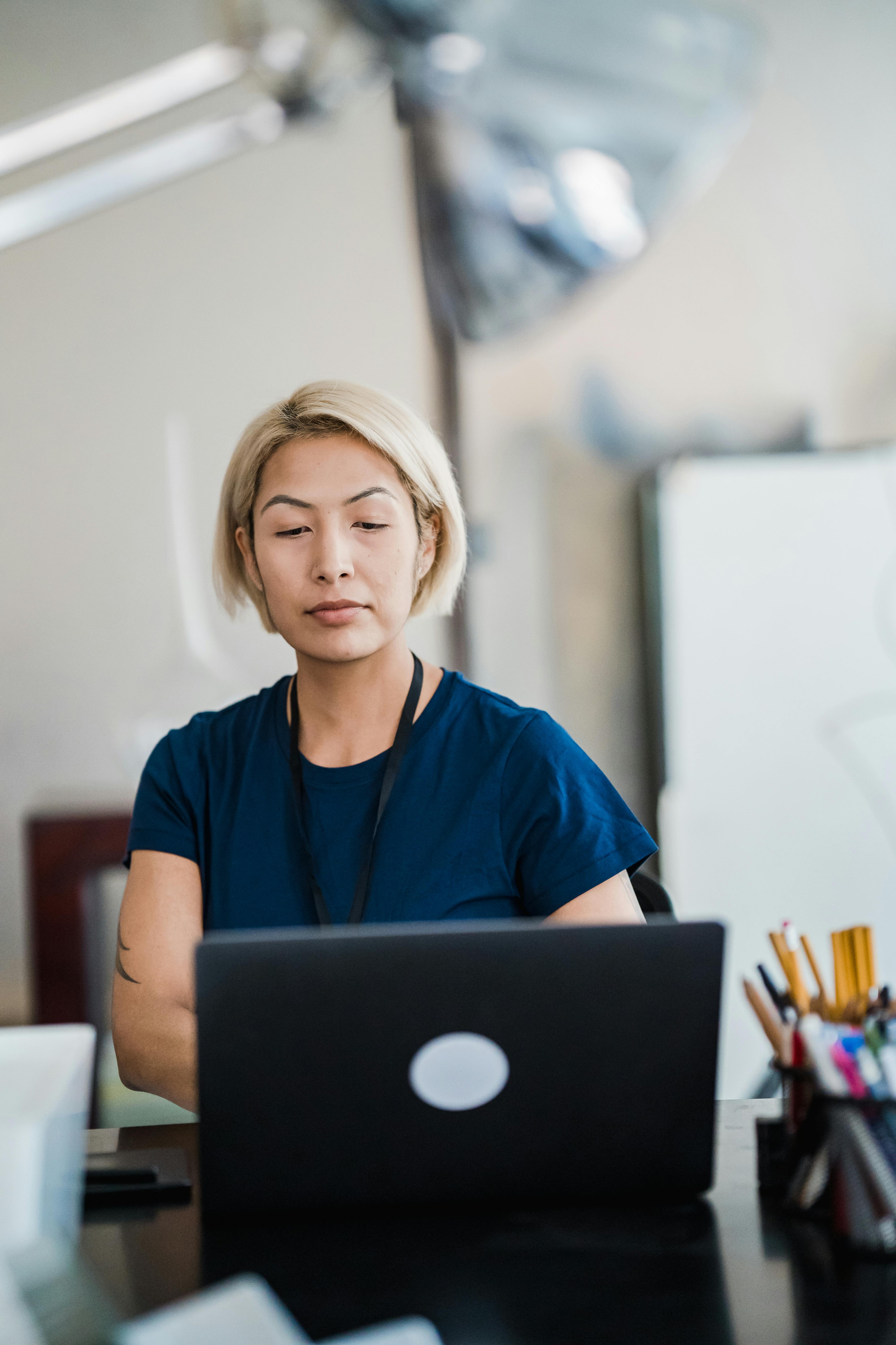 Woman Thinking while Working on Laptop · Free Stock Photo