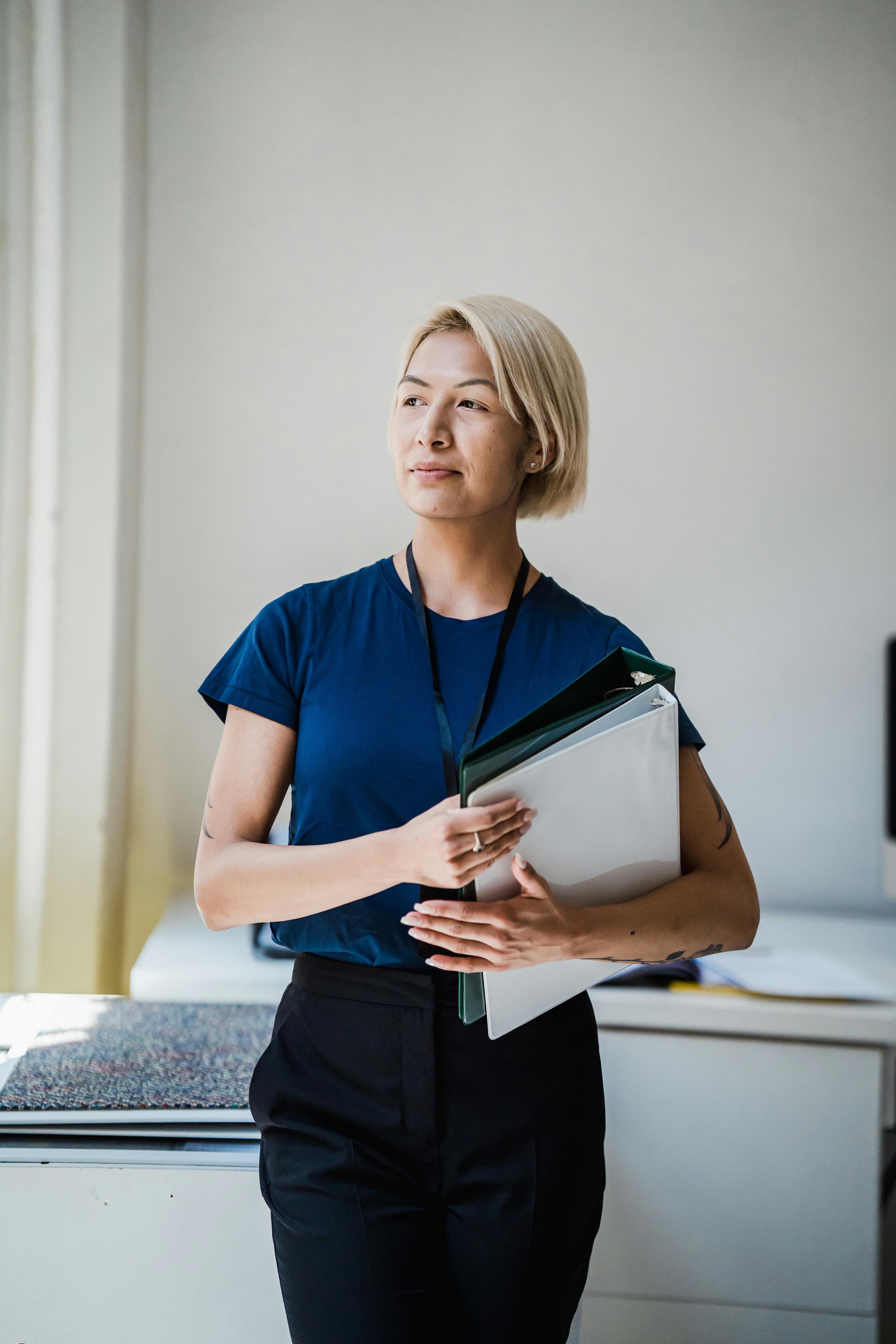 Portrait of Woman in Office Holding Files · Free Stock Photo