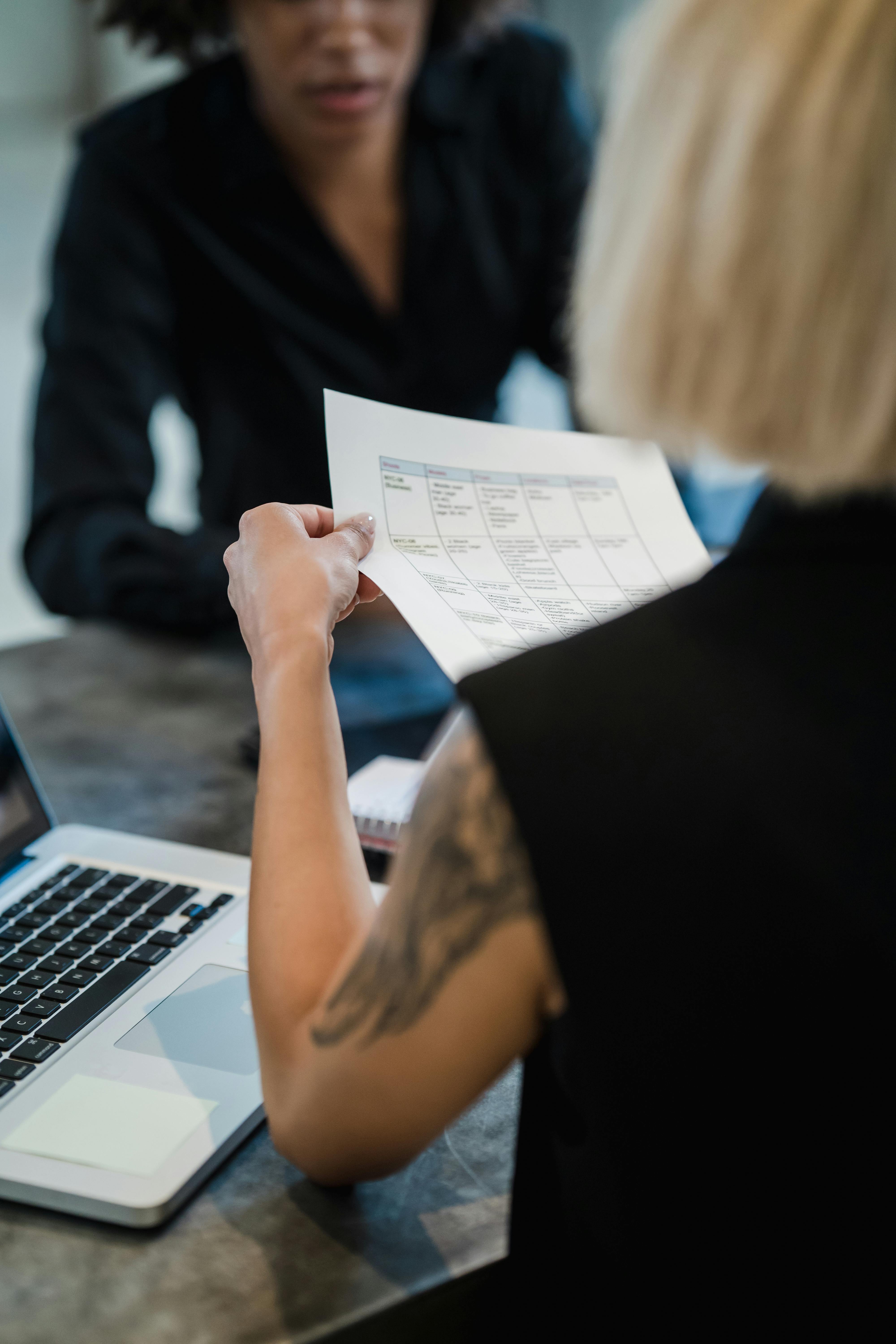 Women Discus Documents in Office · Free Stock Photo