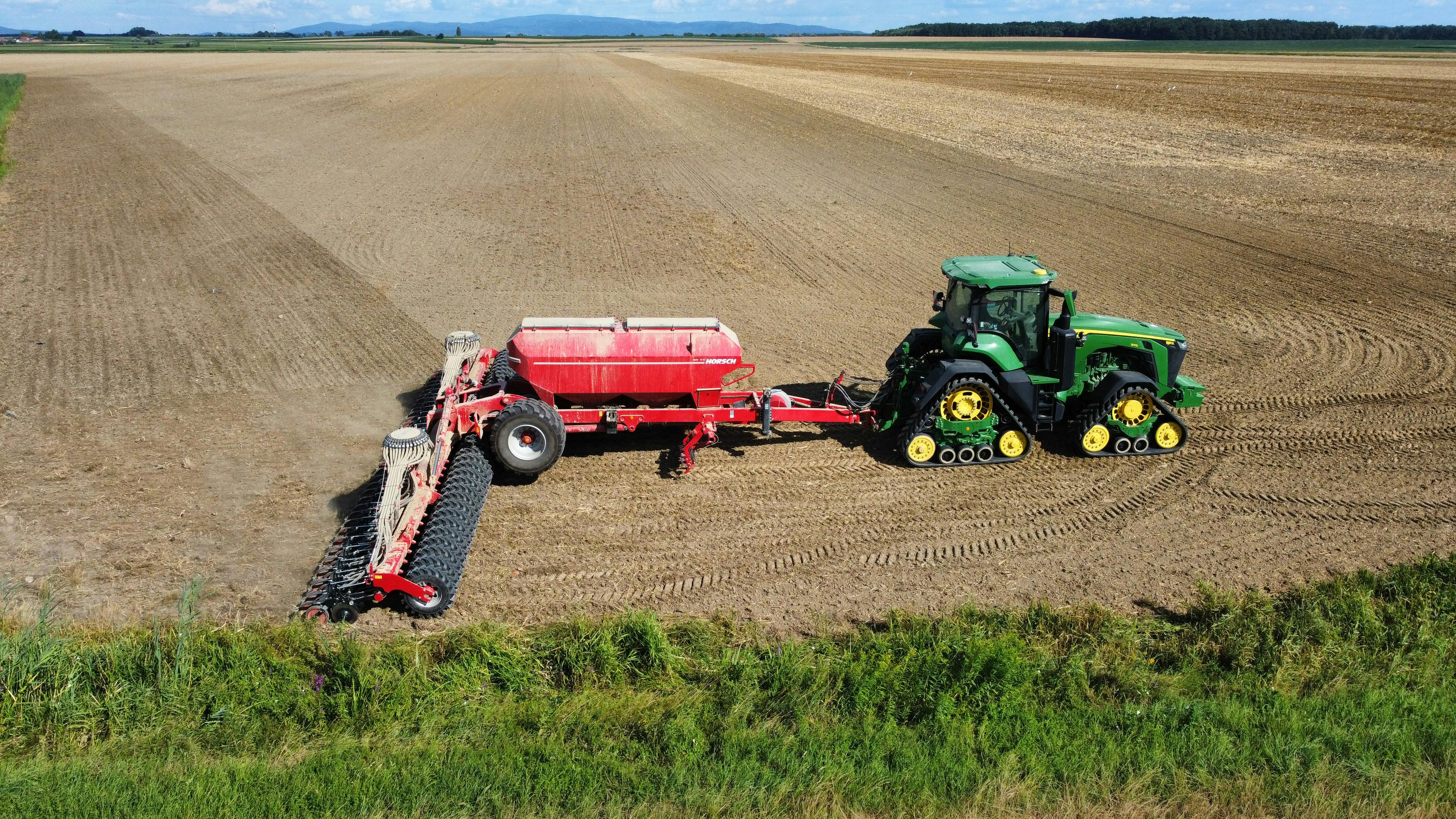 Heavy Machine Tractor Harvesting Crops on an Agricultural Farmland ...