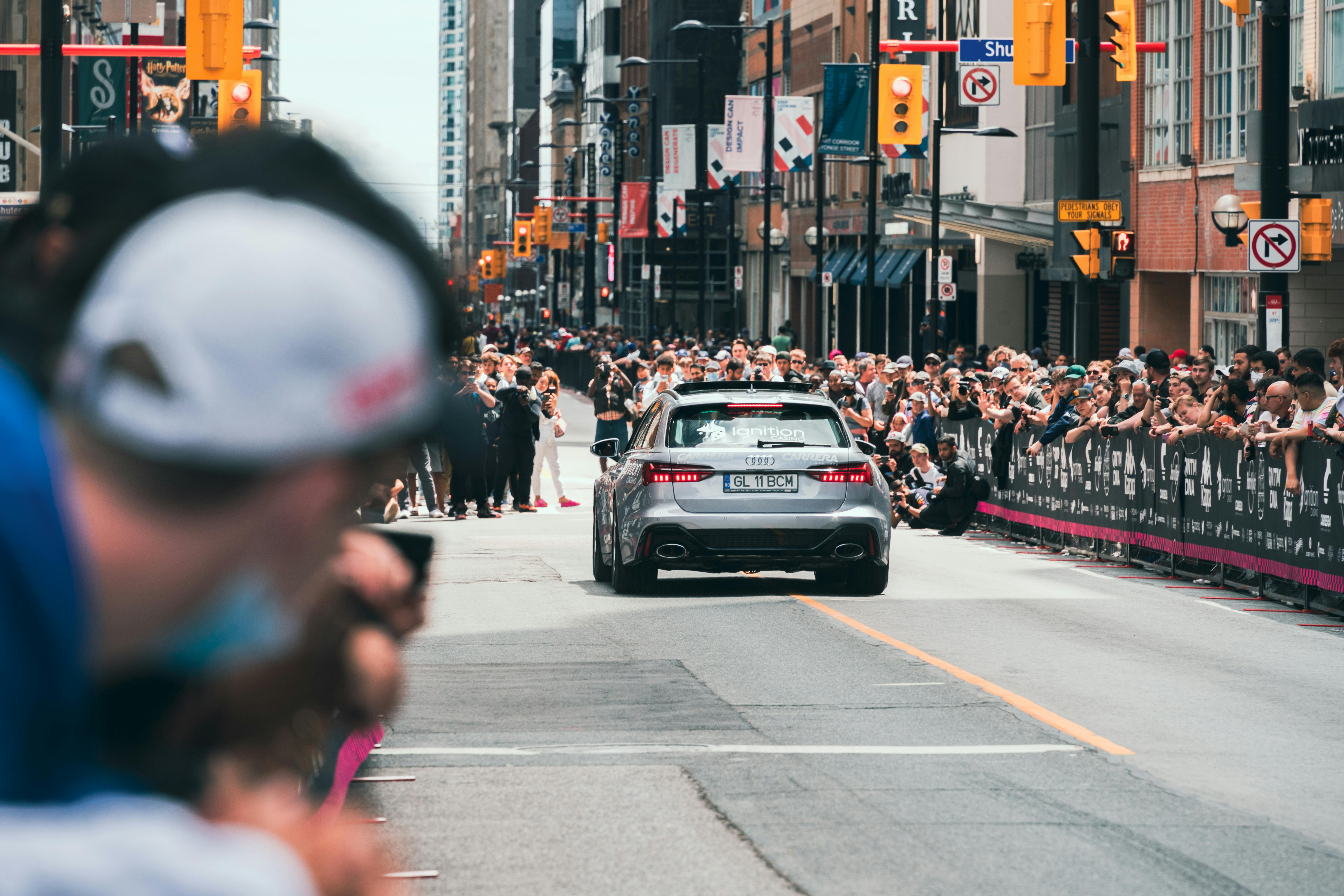Car Driving Beside the Crowd · Free Stock Photo