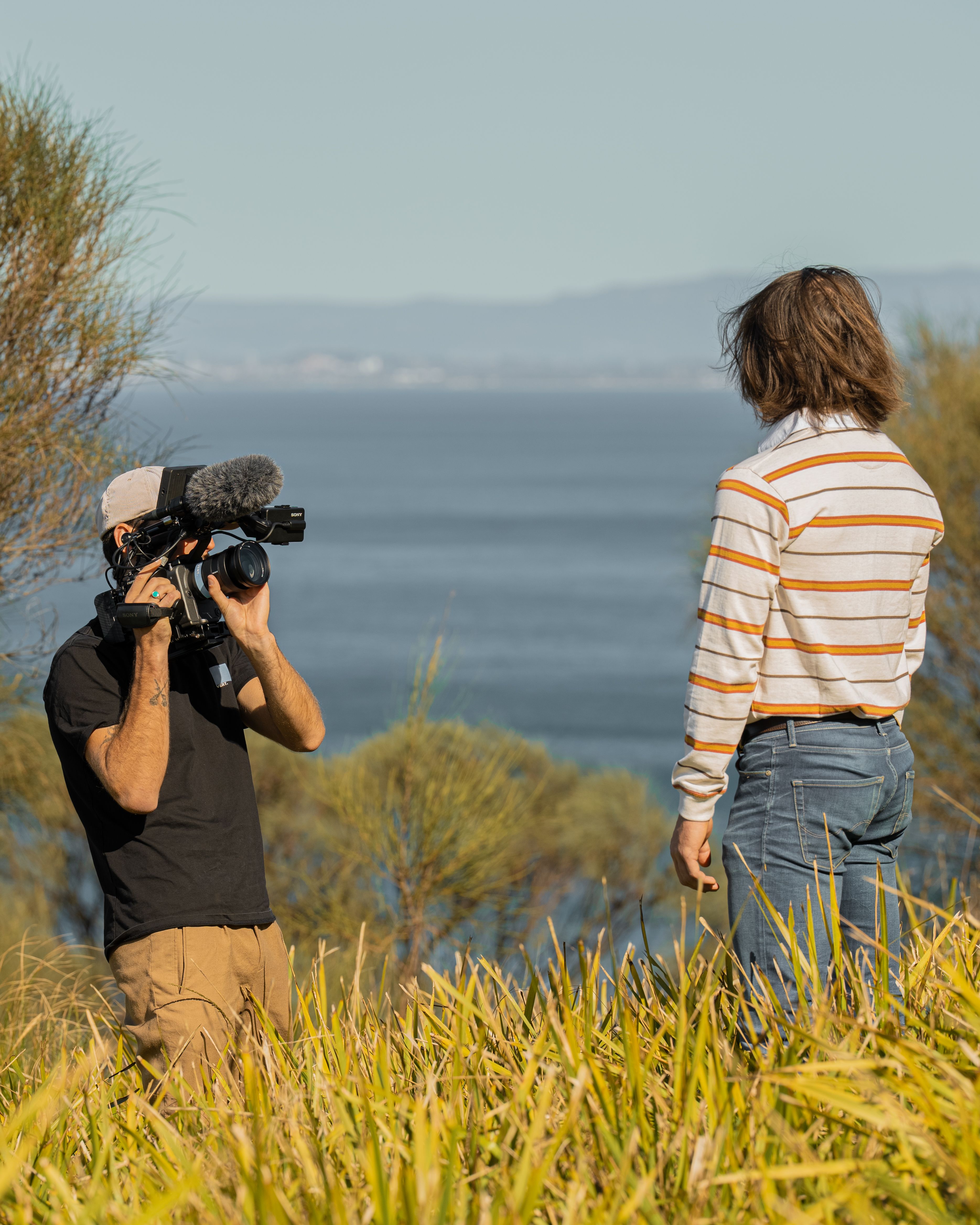Photographer Taking Pictures of Model on Sea Coast · Free Stock Photo