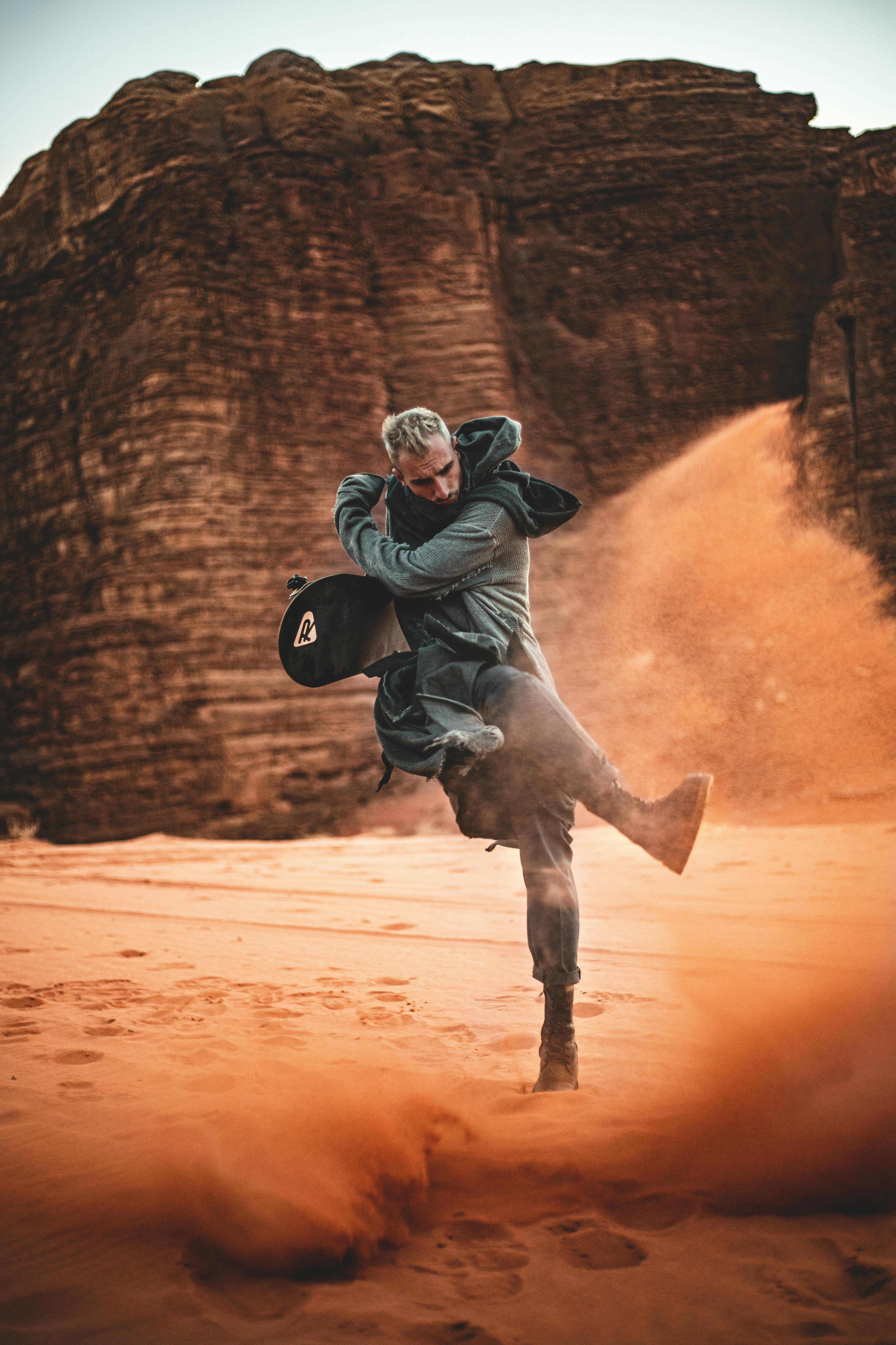 Man Kicking Sand on Desert · Free Stock Photo