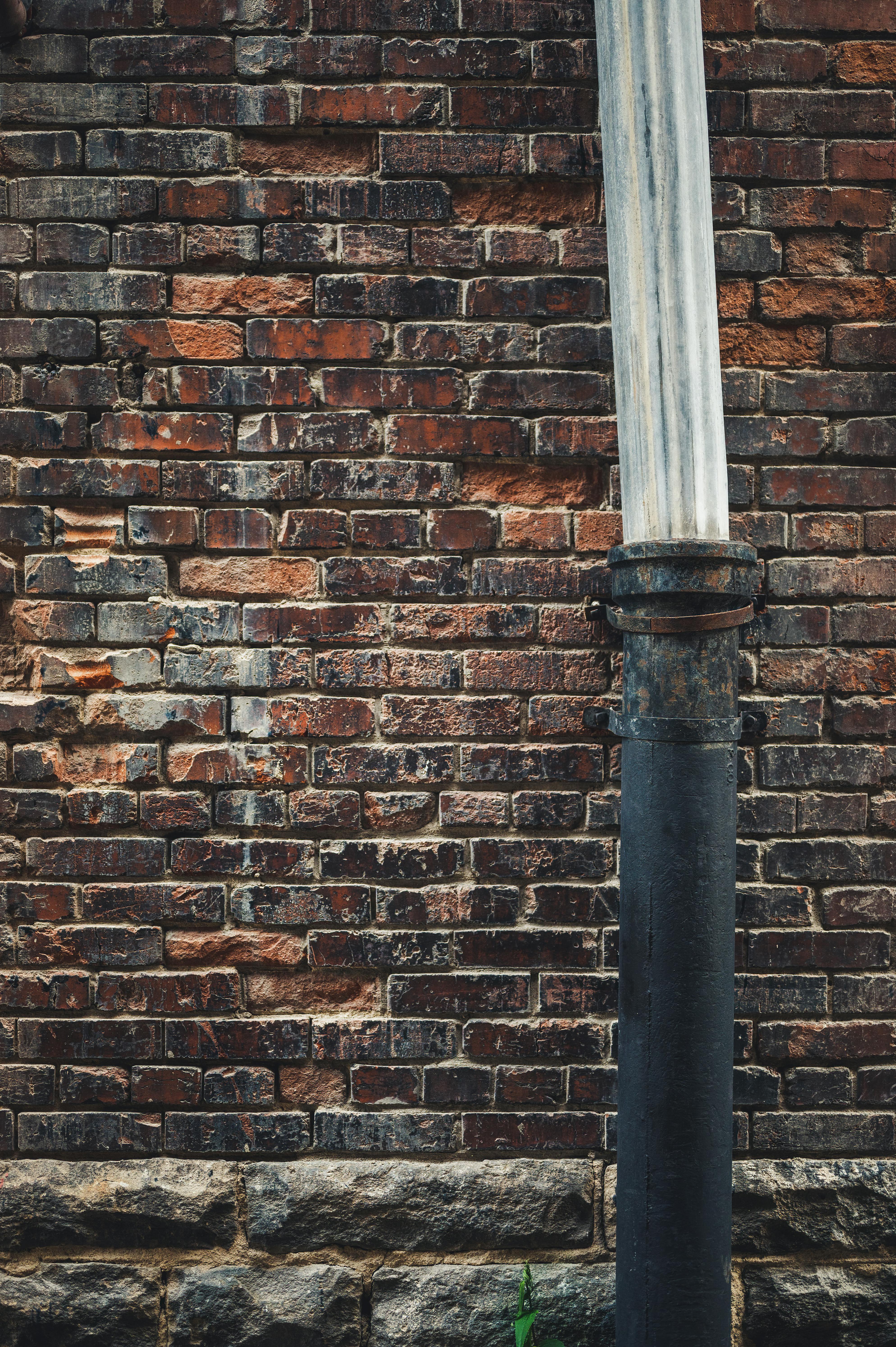 Metal Pipe on Brickwall · Free Stock Photo
