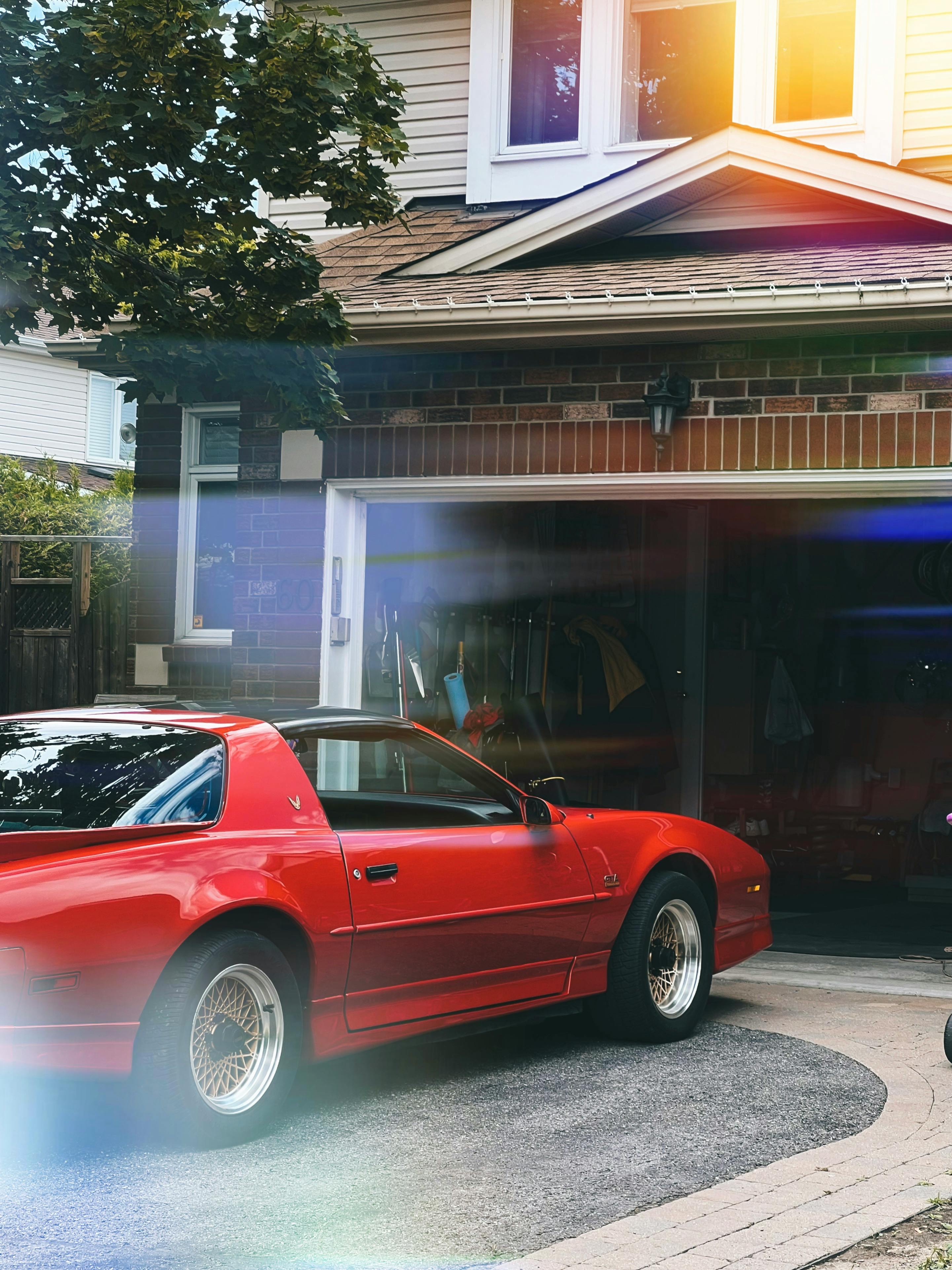 Red Car Parked in Front of the Garage · Free Stock Photo
