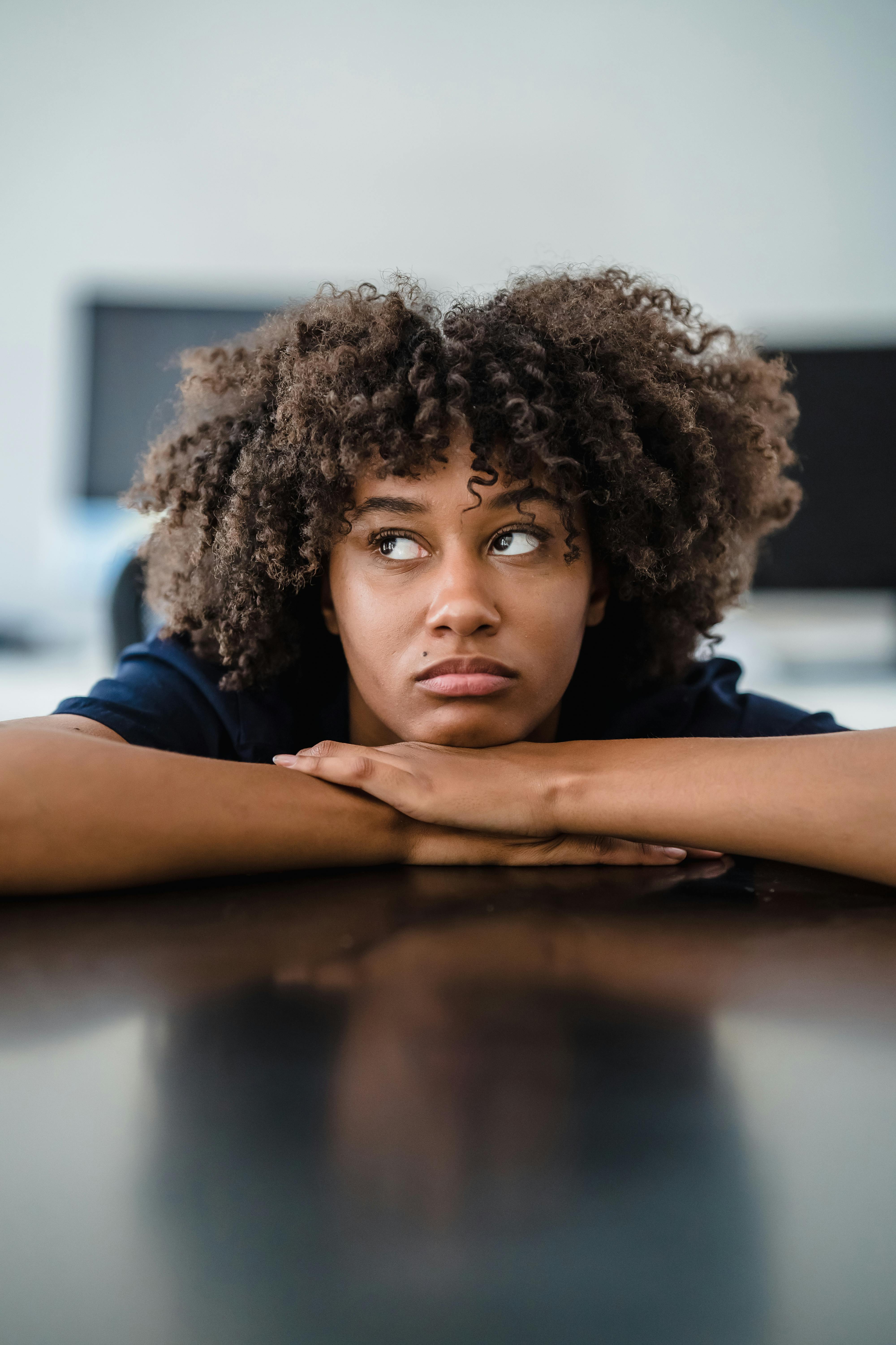 Bored Woman with her Head on her Hands · Free Stock Photo