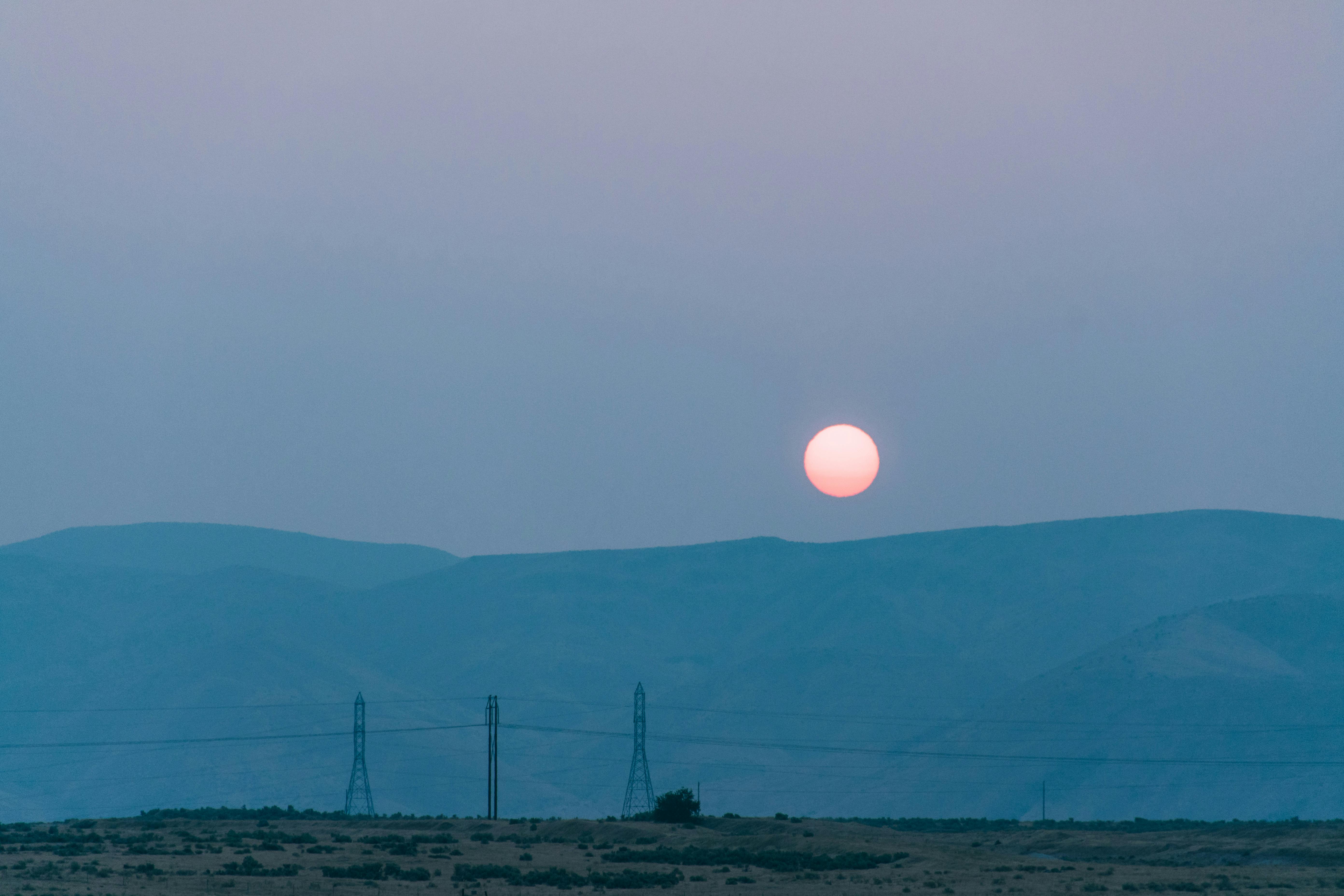 Gray Transmission Posts Near Mountain · Free Stock Photo