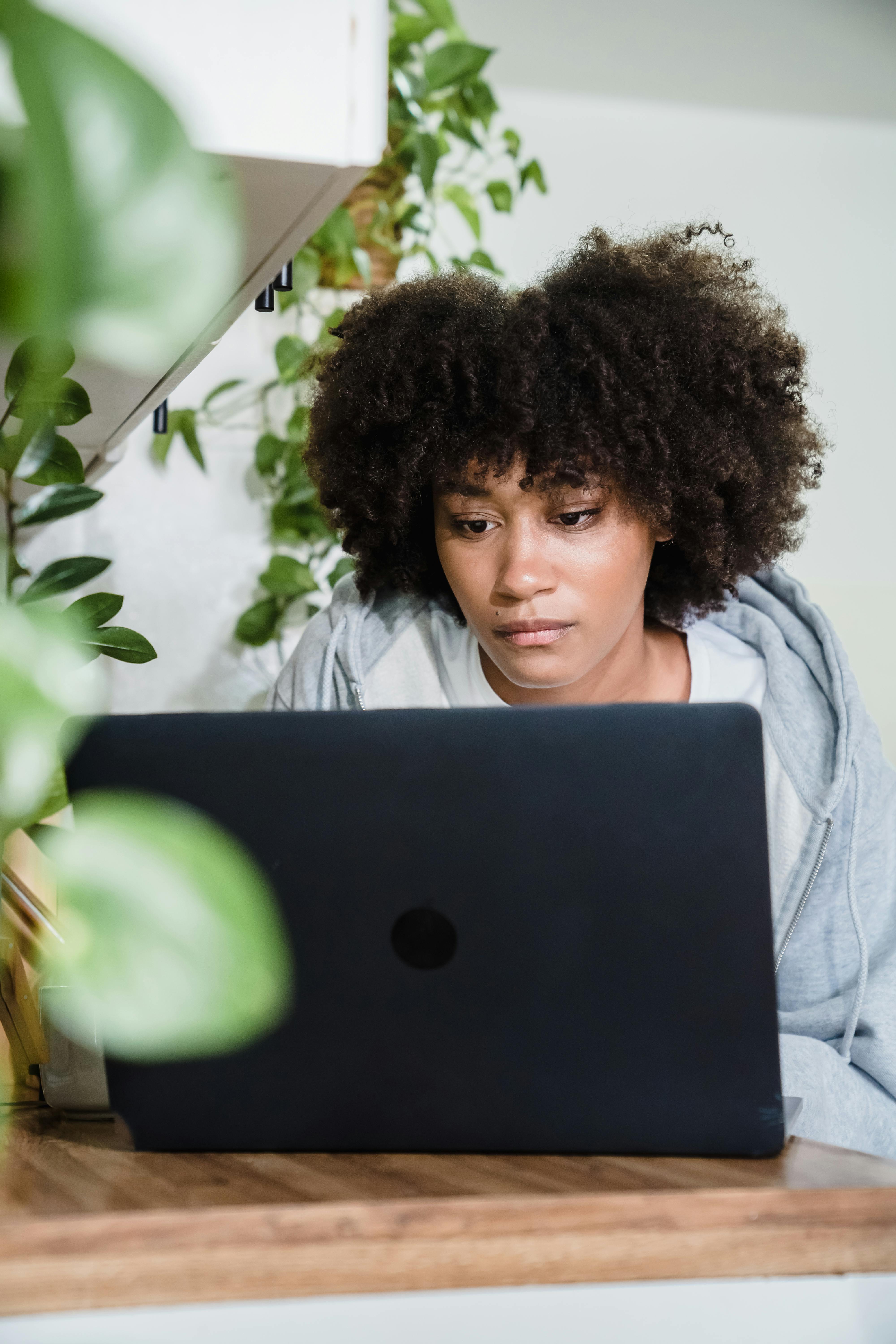 Young Women Using Laptop while Sitting on the Couch · Free Stock Photo