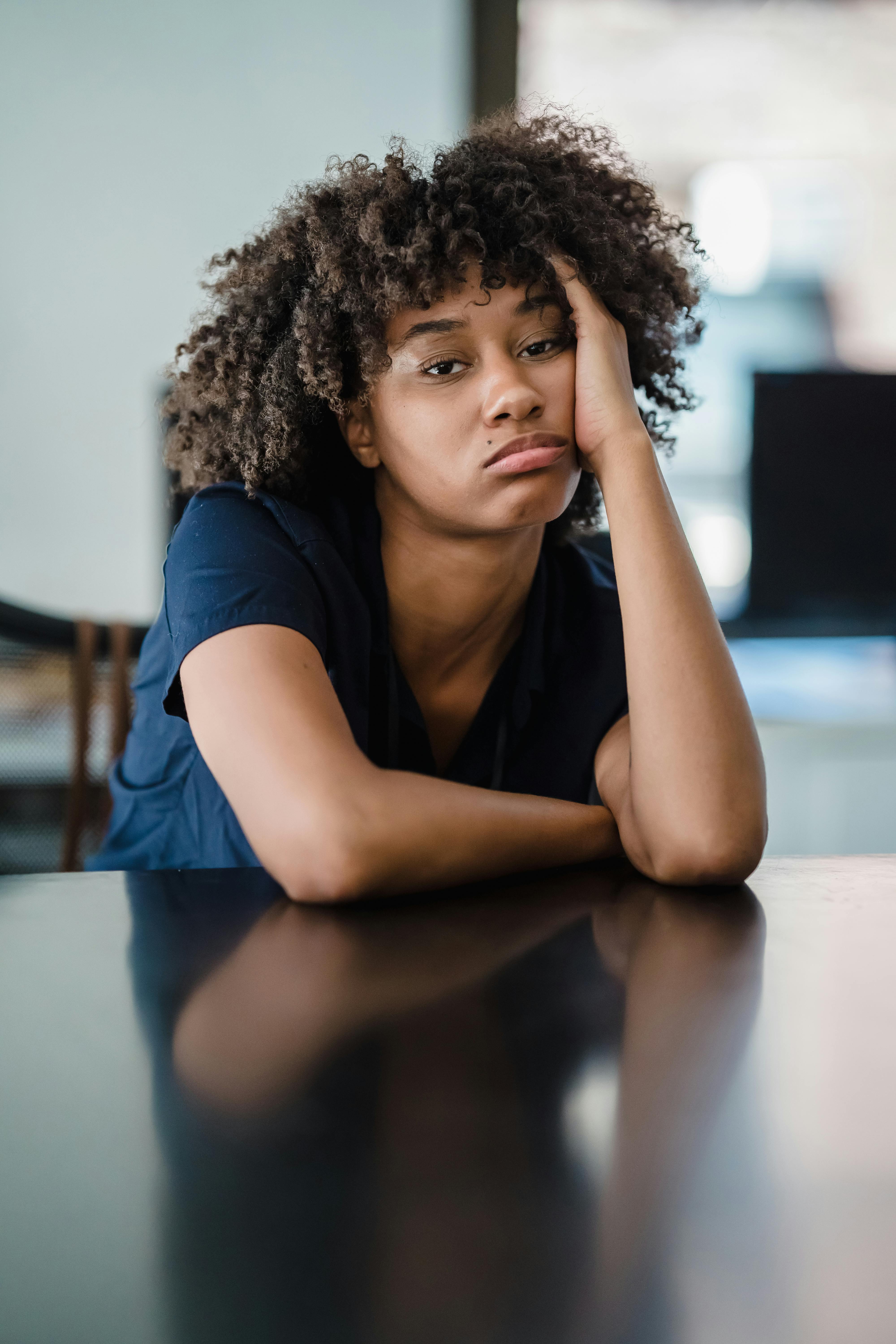 Bored Woman Sitting at Table · Free Stock Photo