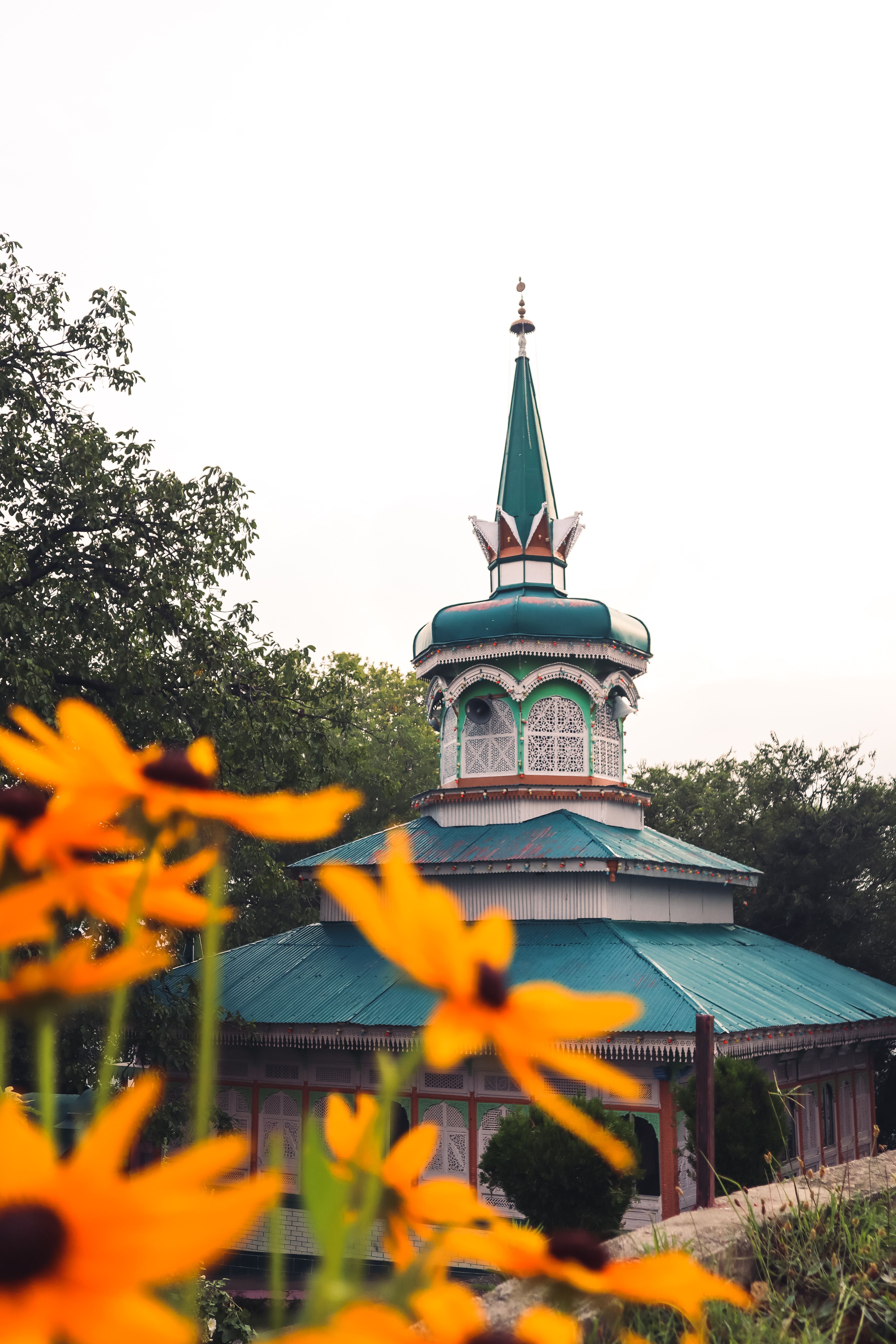 Tower of a Temple and Flowers · Free Stock Photo