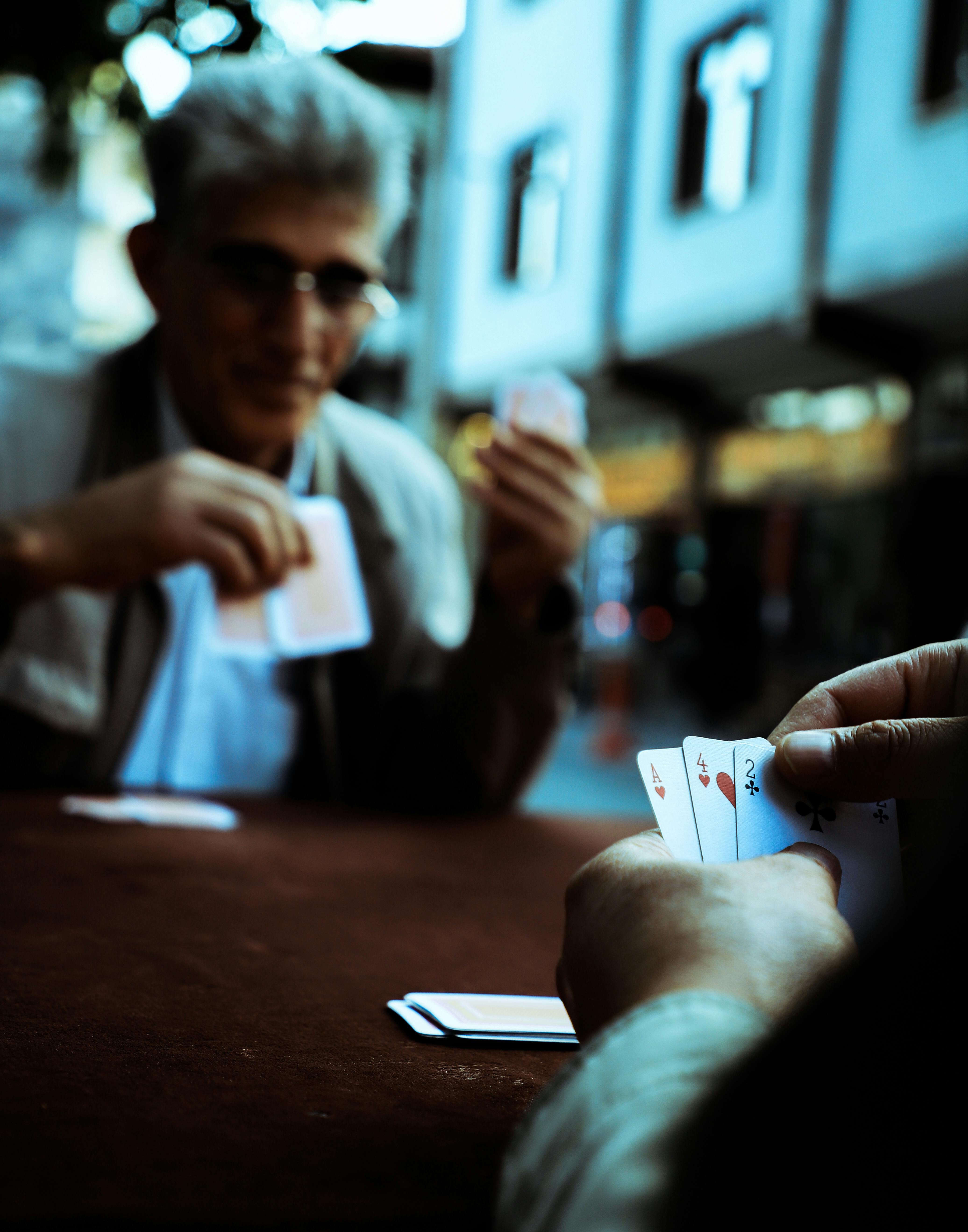 A Person Holding Plating Cards · Free Stock Photo
