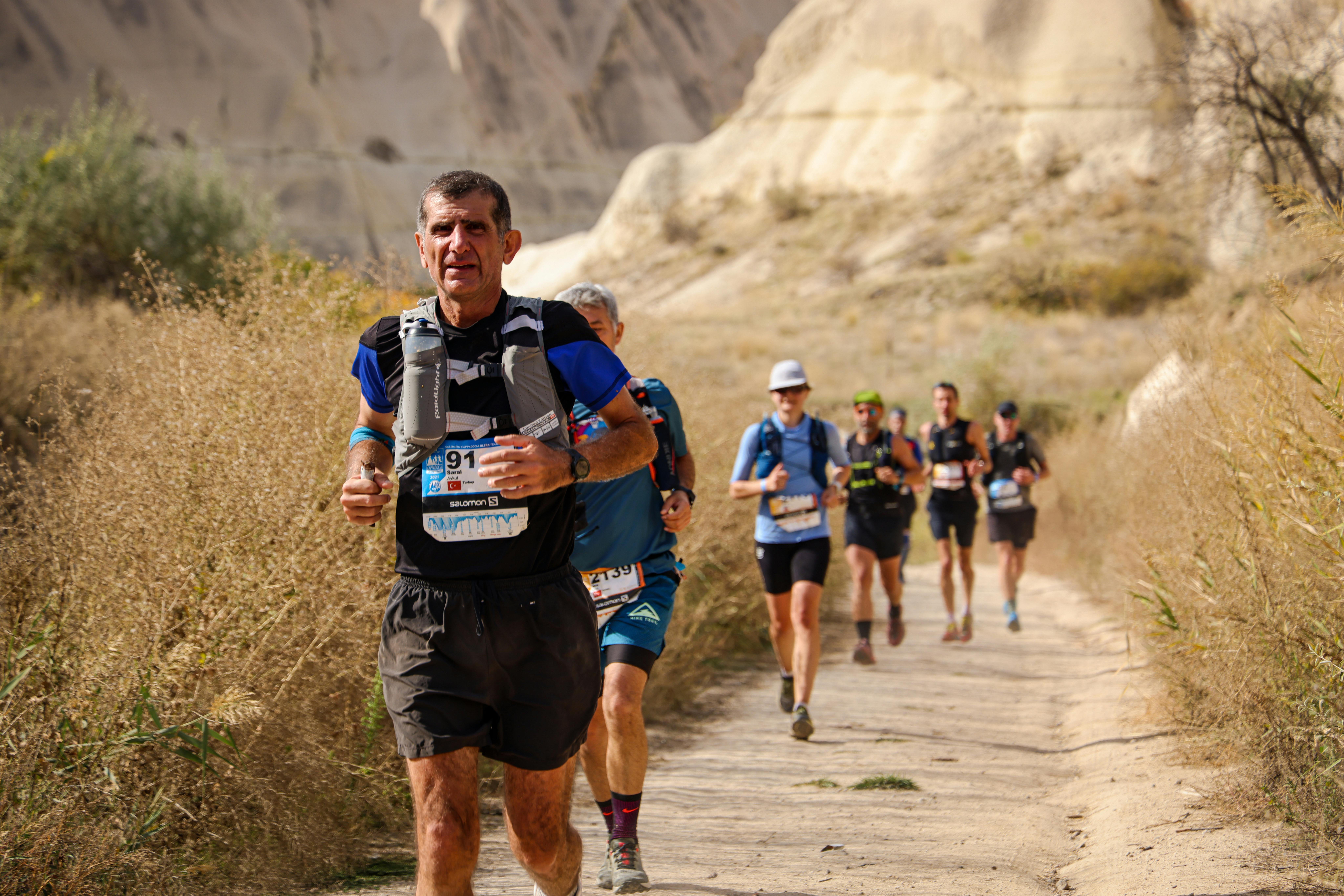 People Running on Brown Dirt Road · Free Stock Photo