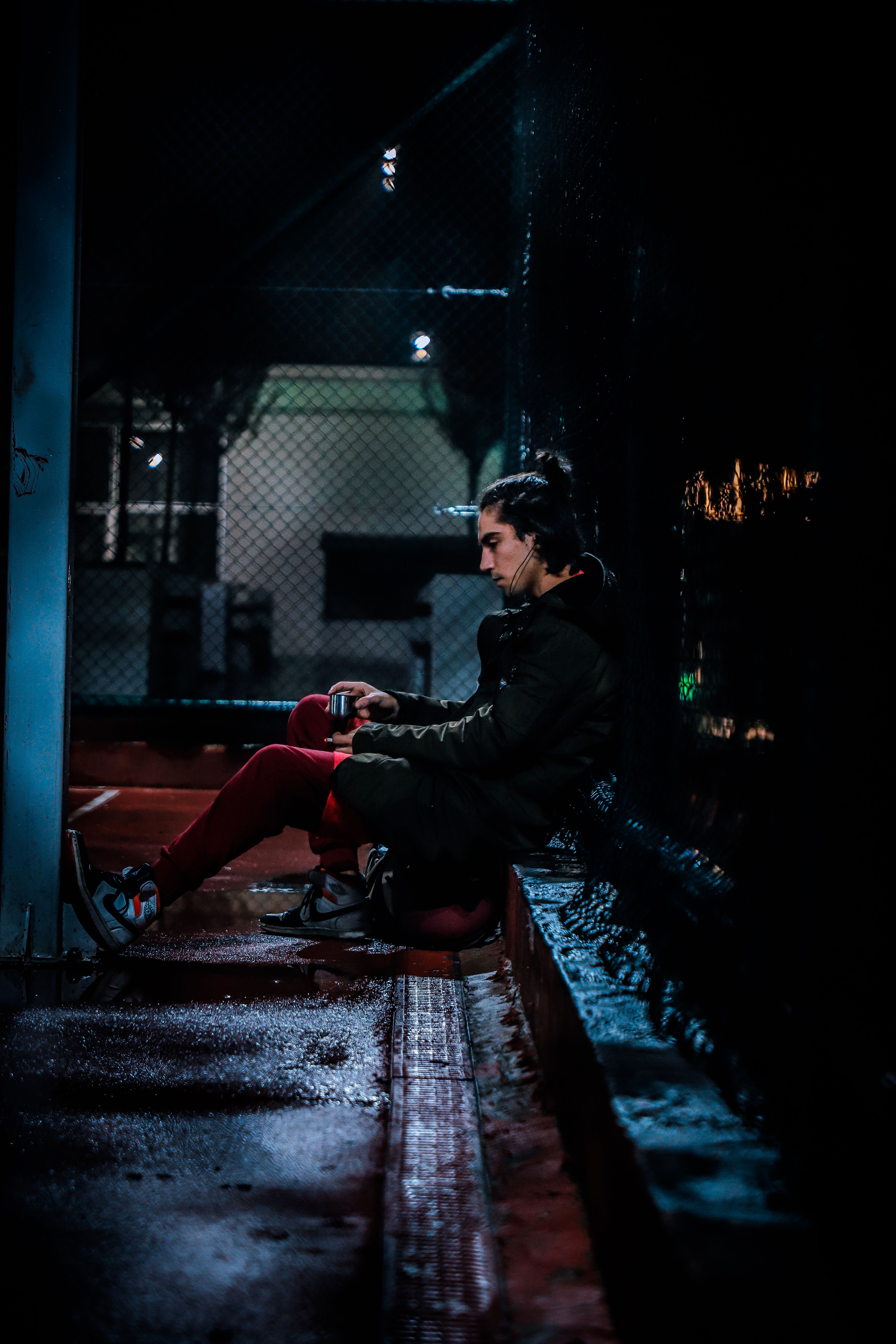 Person Wearing Jacket Sitting on The Floor · Free Stock Photo