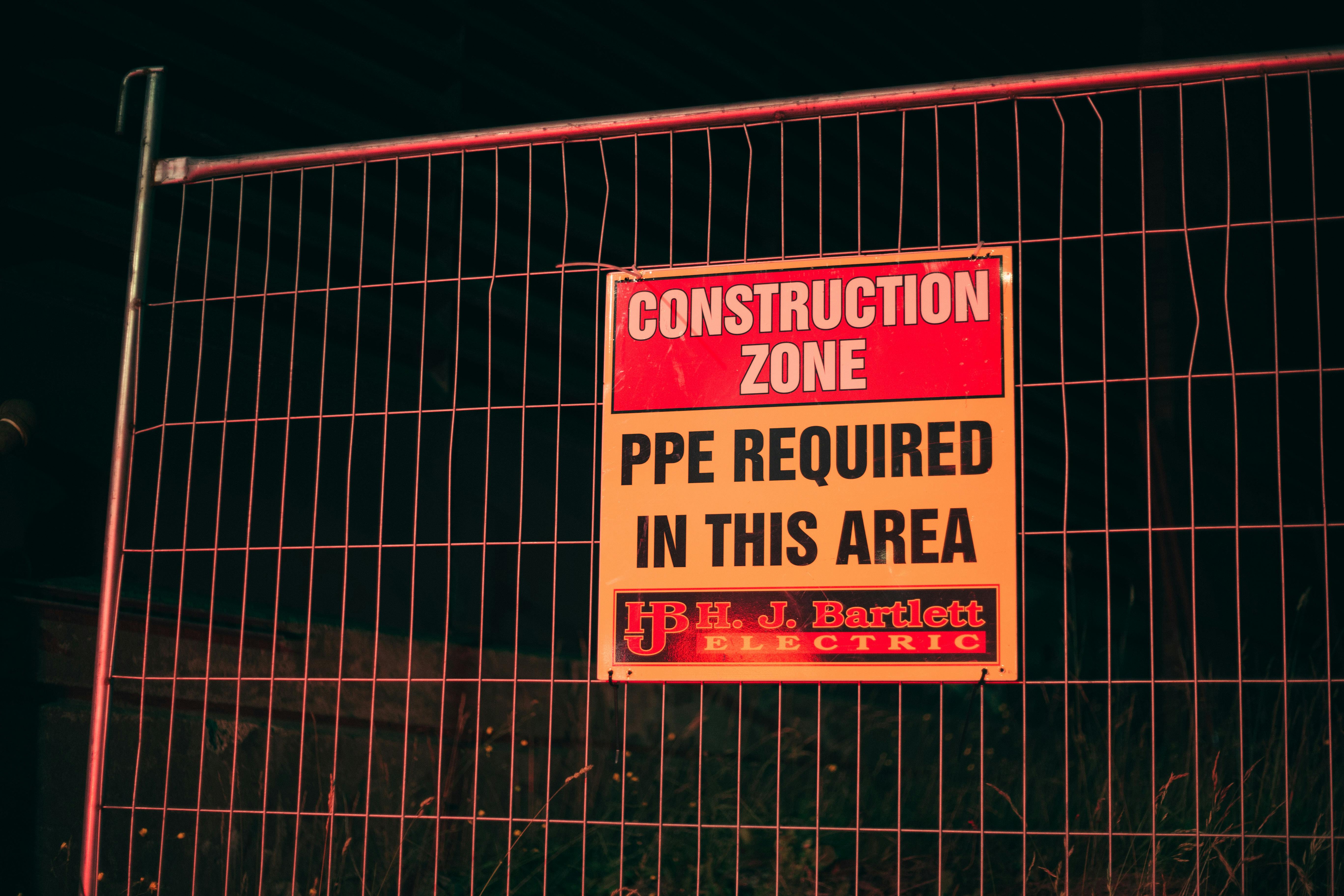 Signage Hanging on Metal Fence · Free Stock Photo