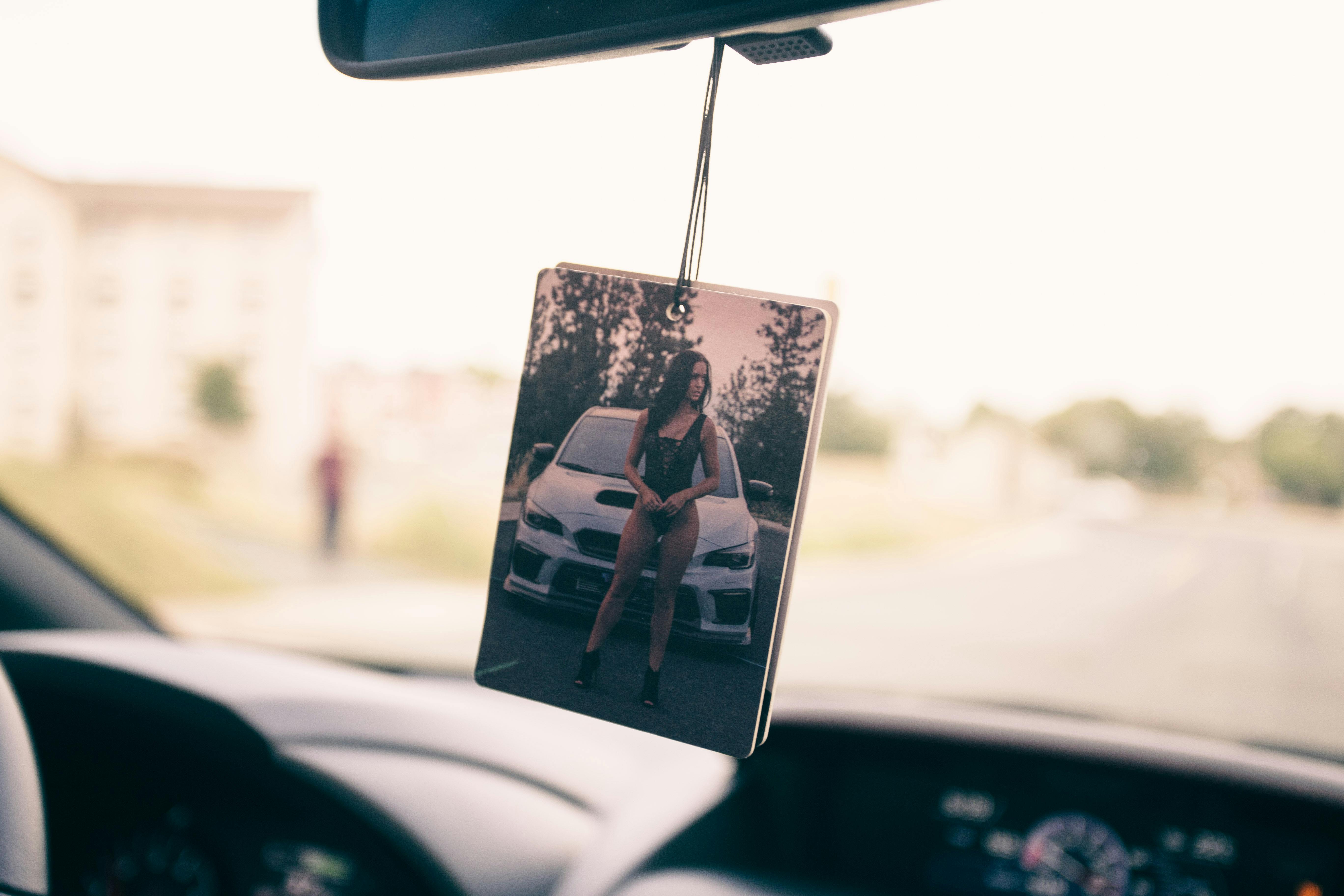 A Picture Hanging on a Rear View Mirror in the Car · Free Stock Photo