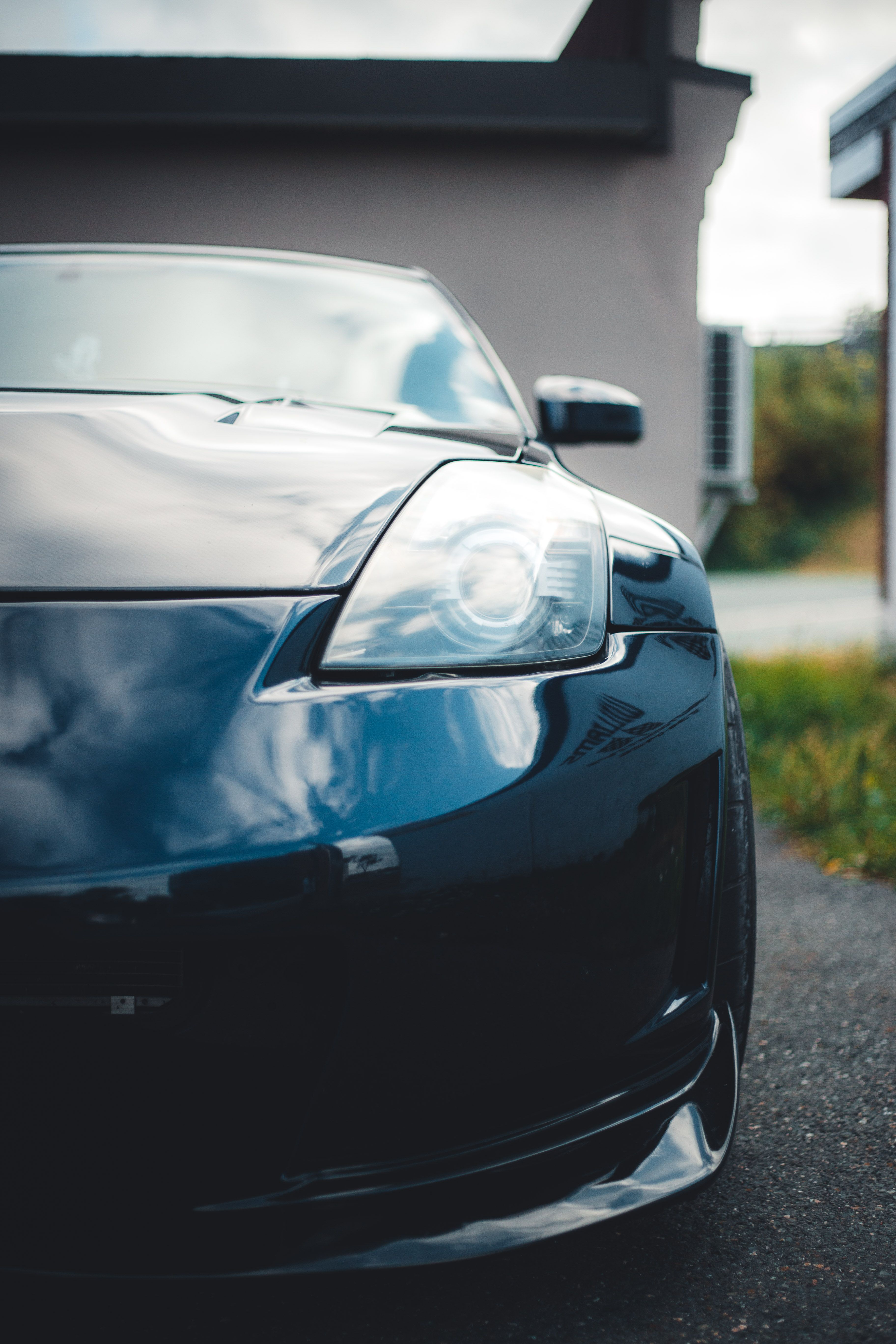 Closeup of a Black Car in Front of a House · Free Stock Photo
