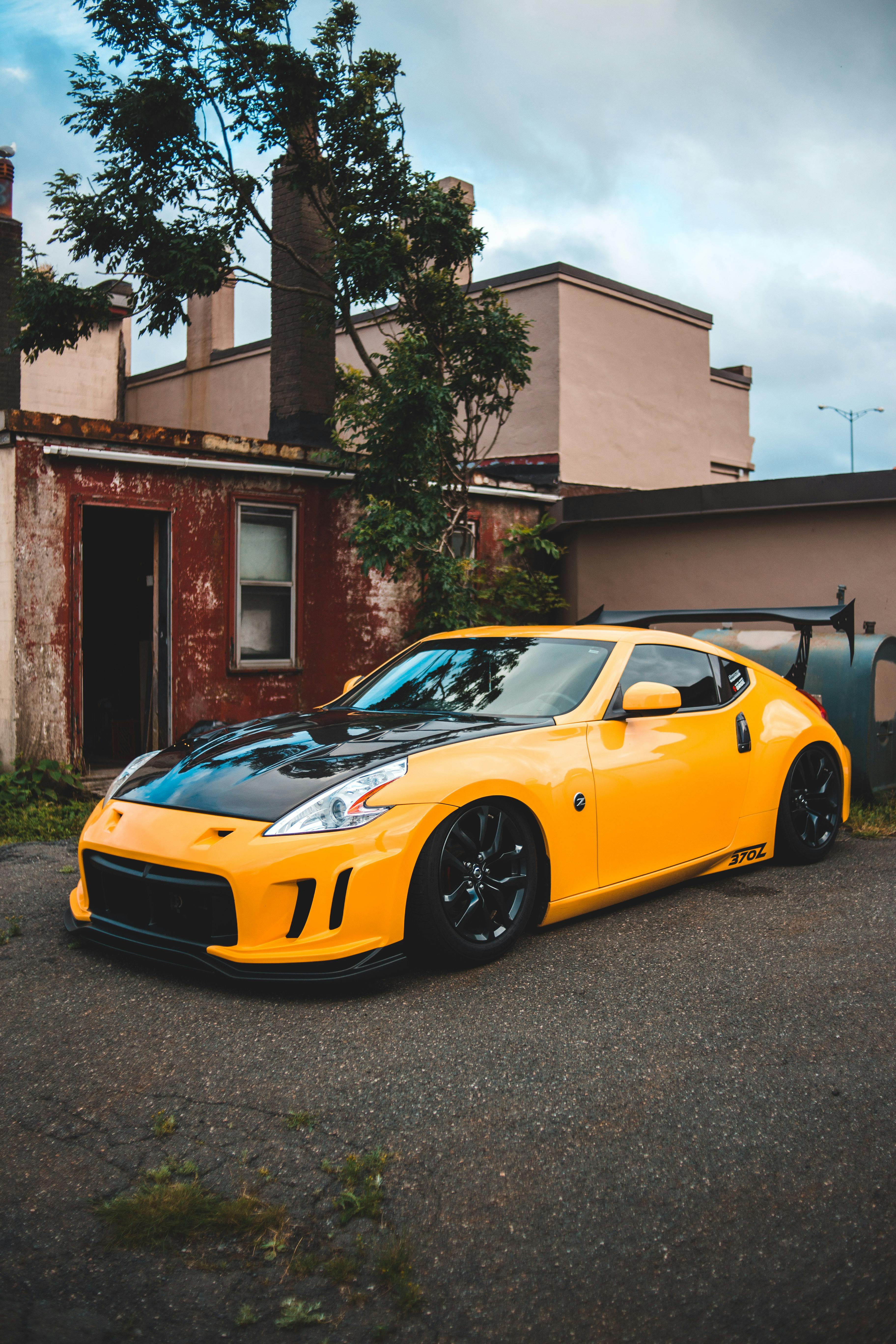 Yellow Sportscar with Black Hood in a Parking Lot · Free Stock Photo