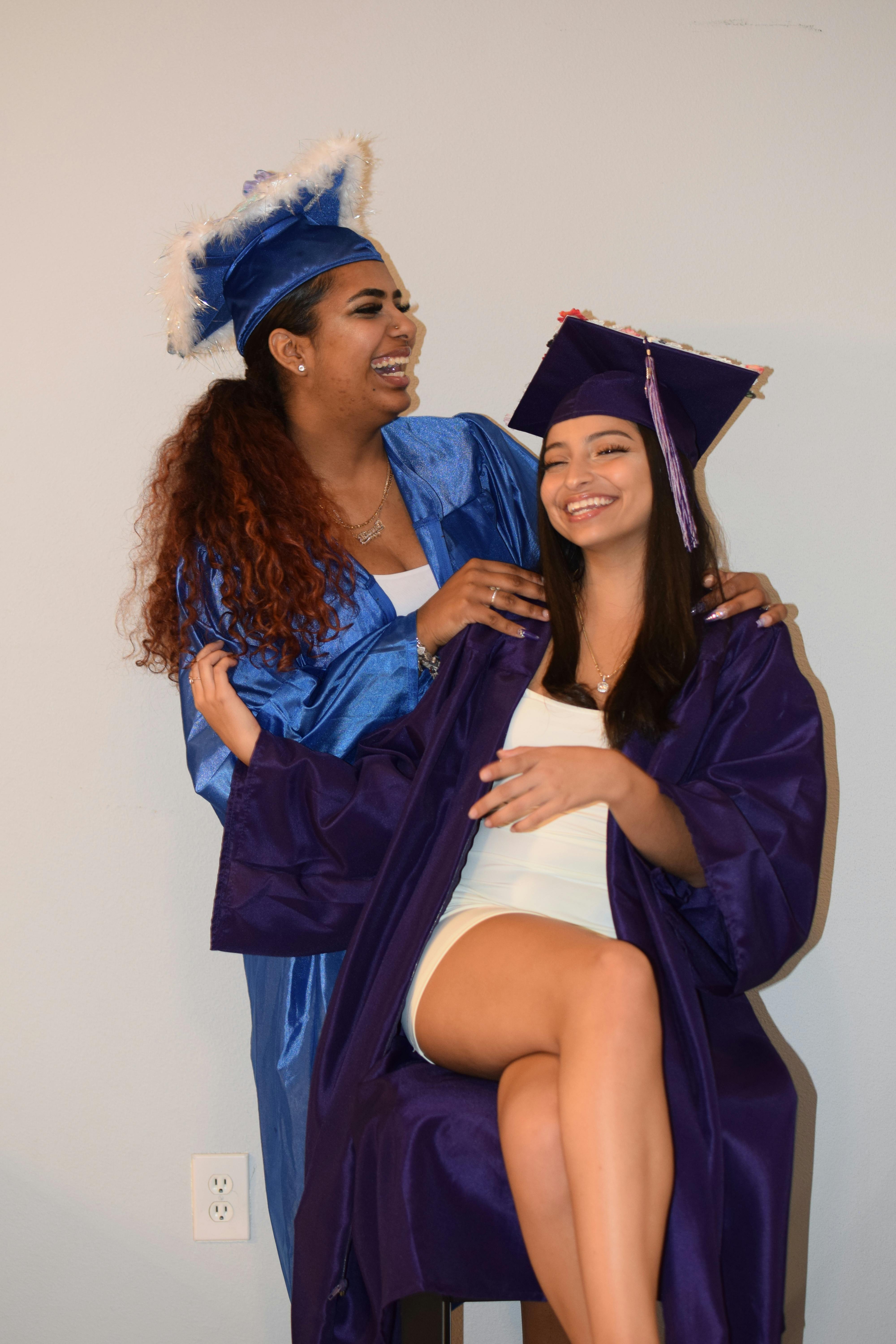 Two Women Wearing Graduation Gowns · Free Stock Photo