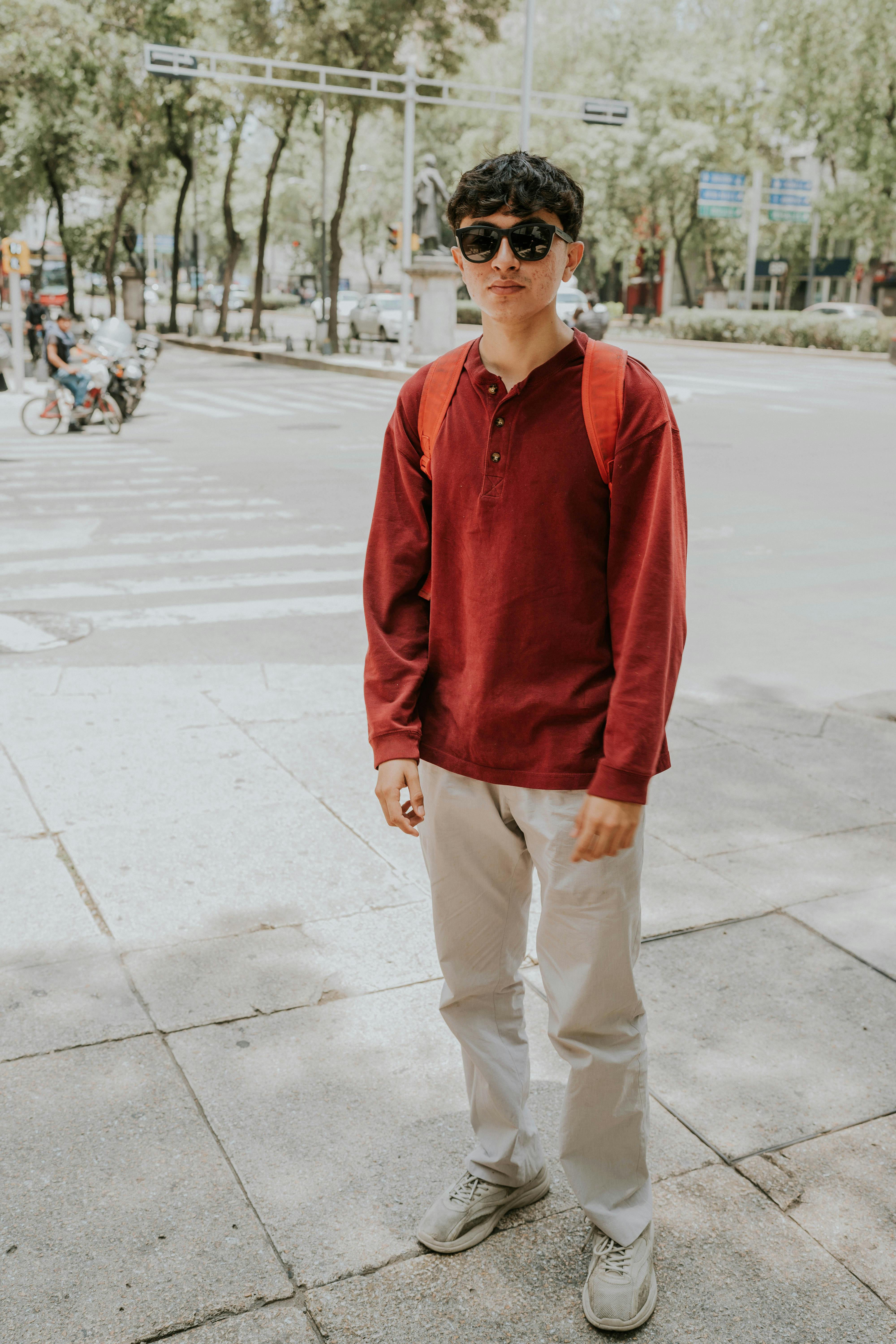 Man in Red Sweatshirt Standing on the Street · Free Stock Photo