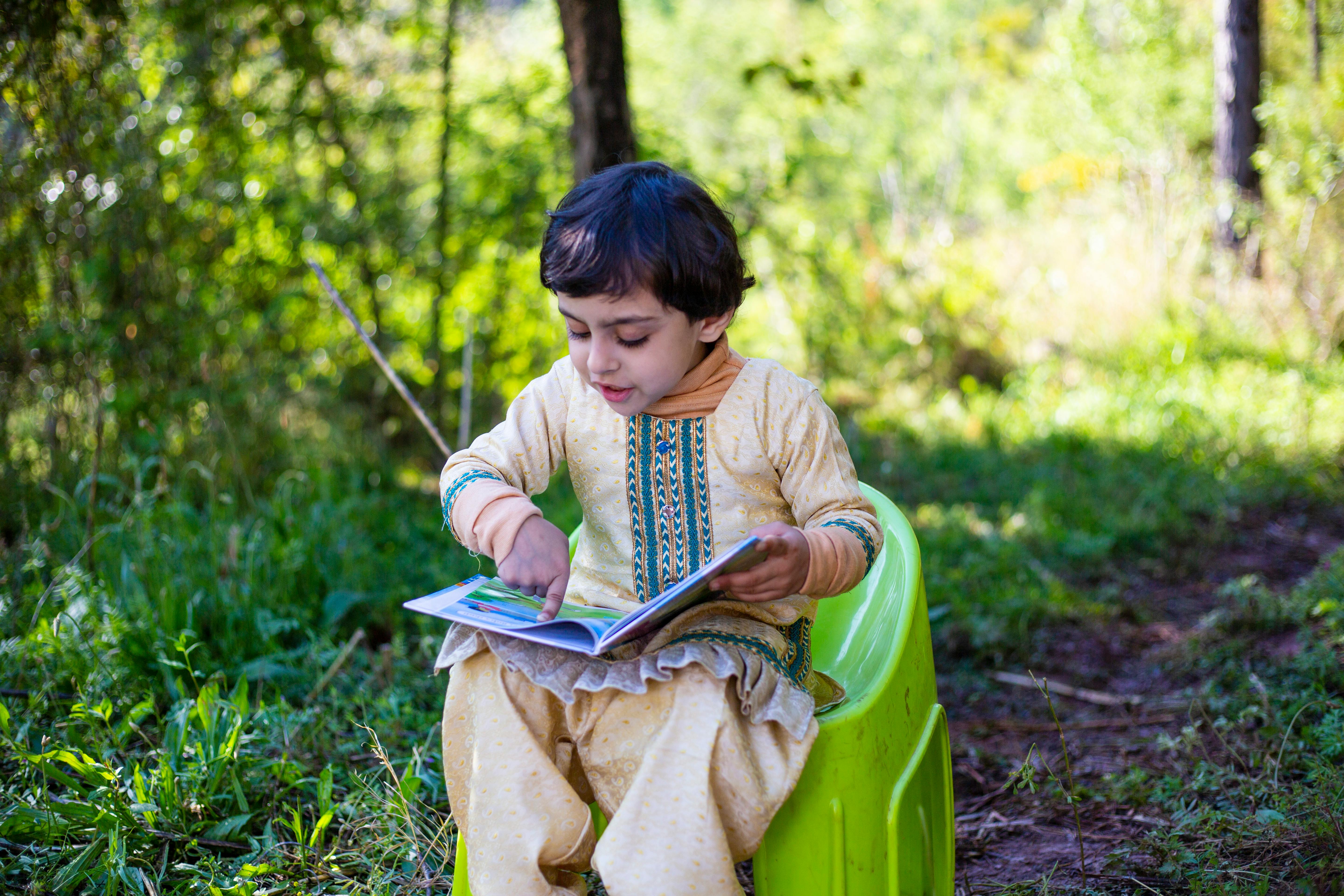 A Boy Reading a Book Alone · Free Stock Photo