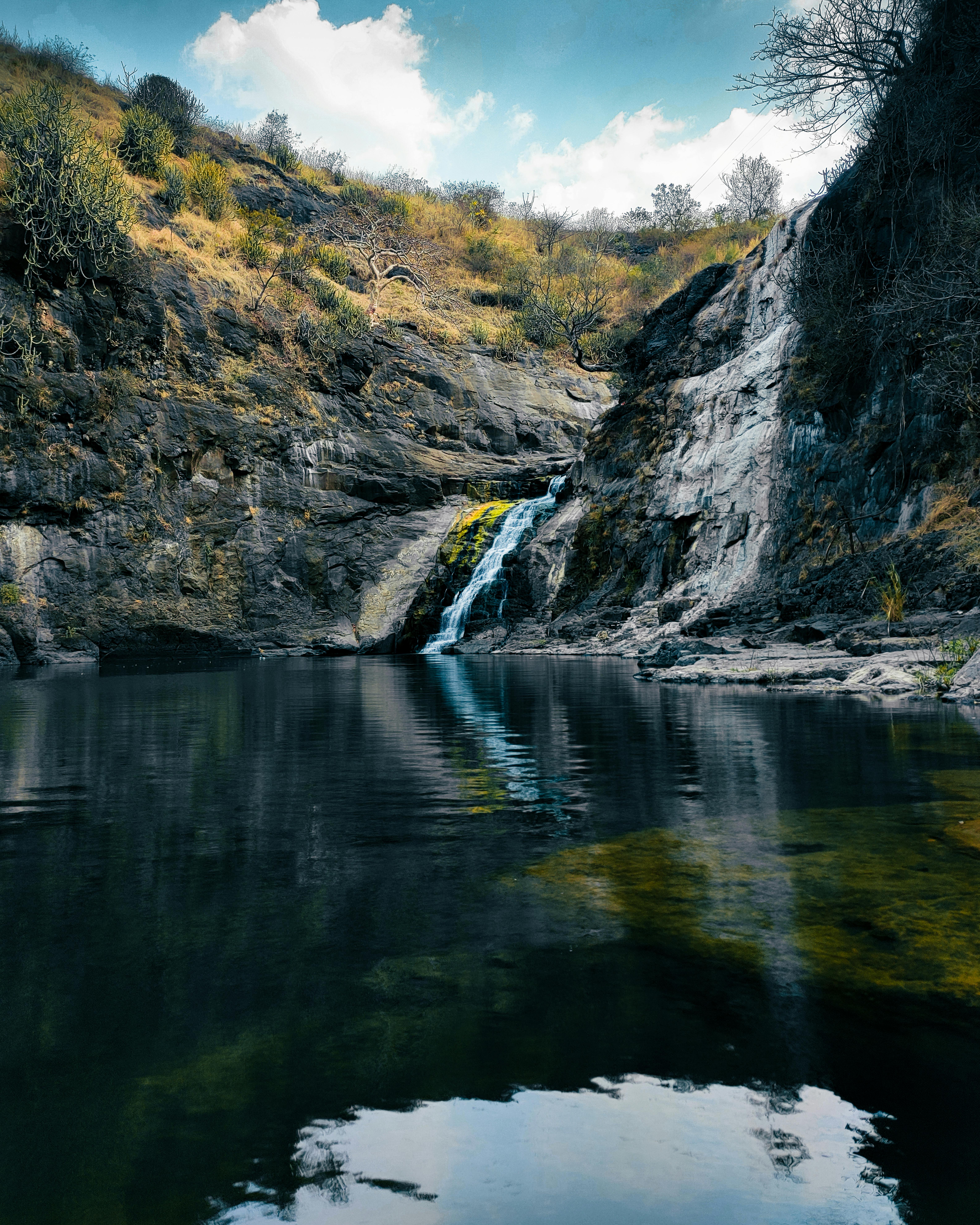 A Waterfall on a Rock Formation Near the River · Free Stock Photo
