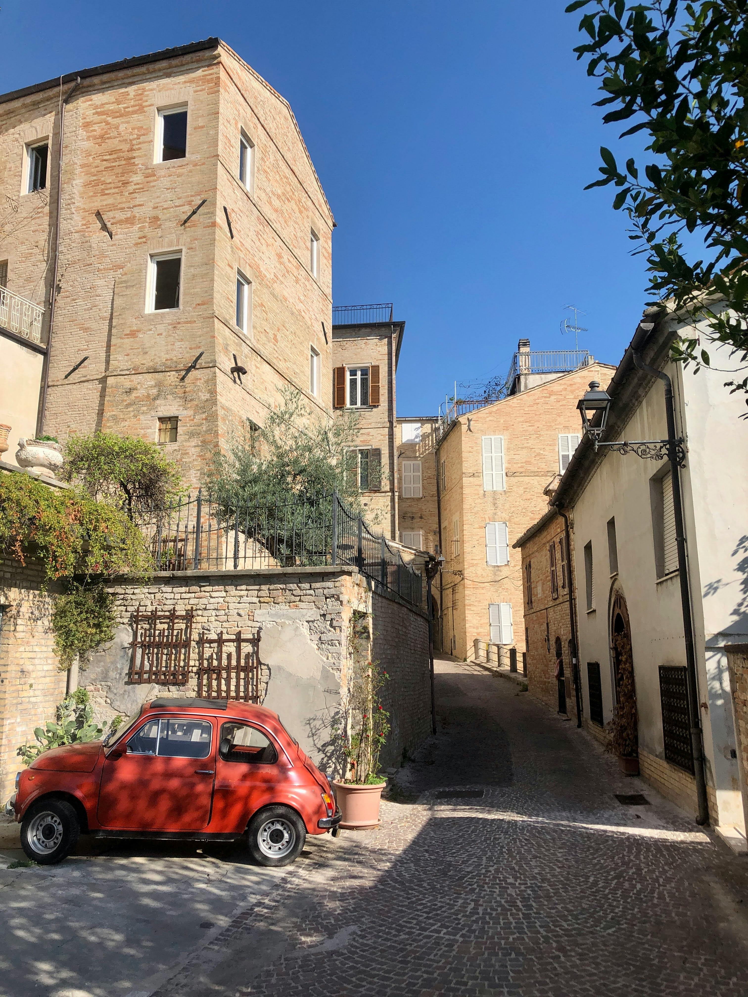 Car and Buildings in Alley · Free Stock Photo