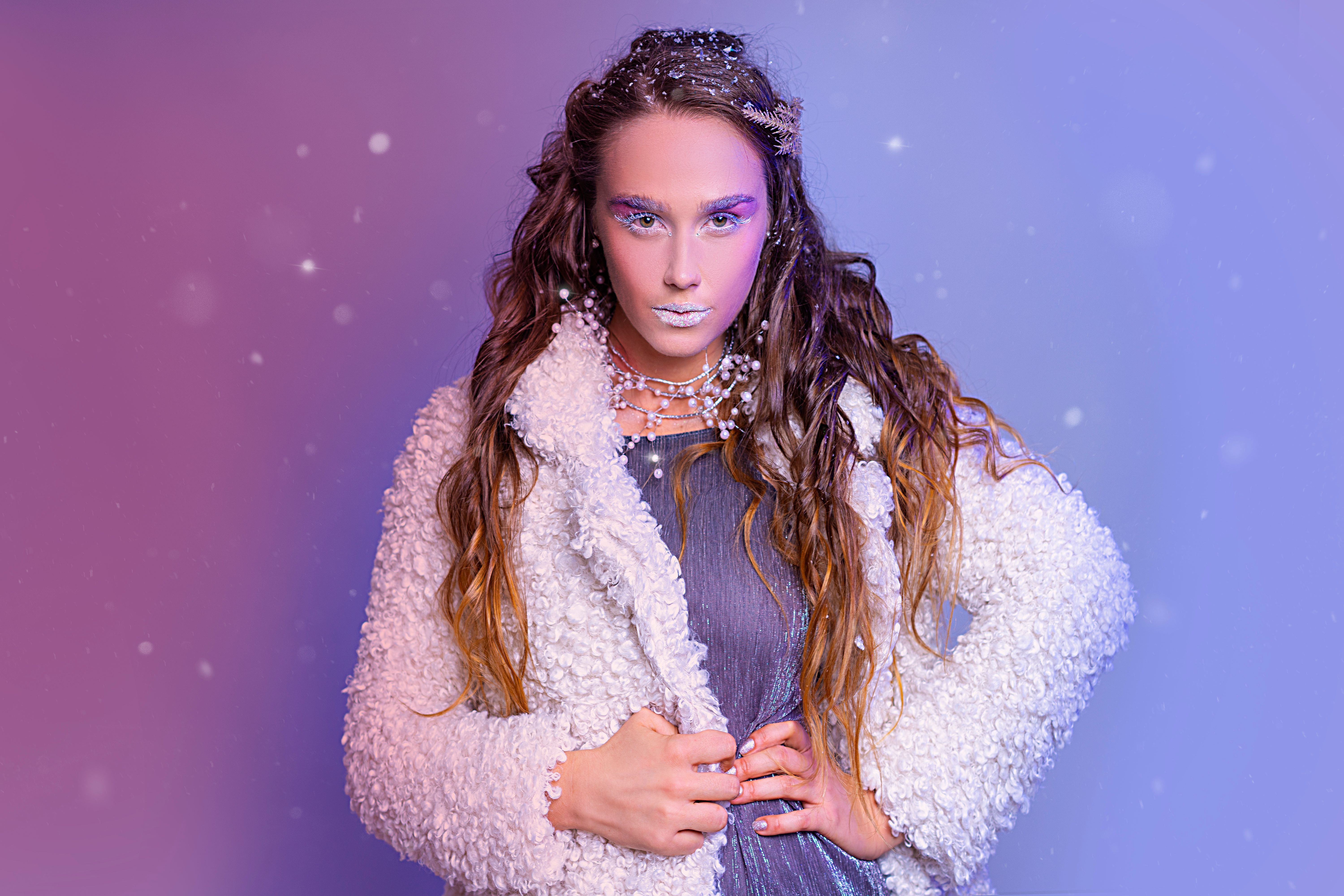Studio Shoot of a Model Wearing a White Jacket and Diamond Earrings ...