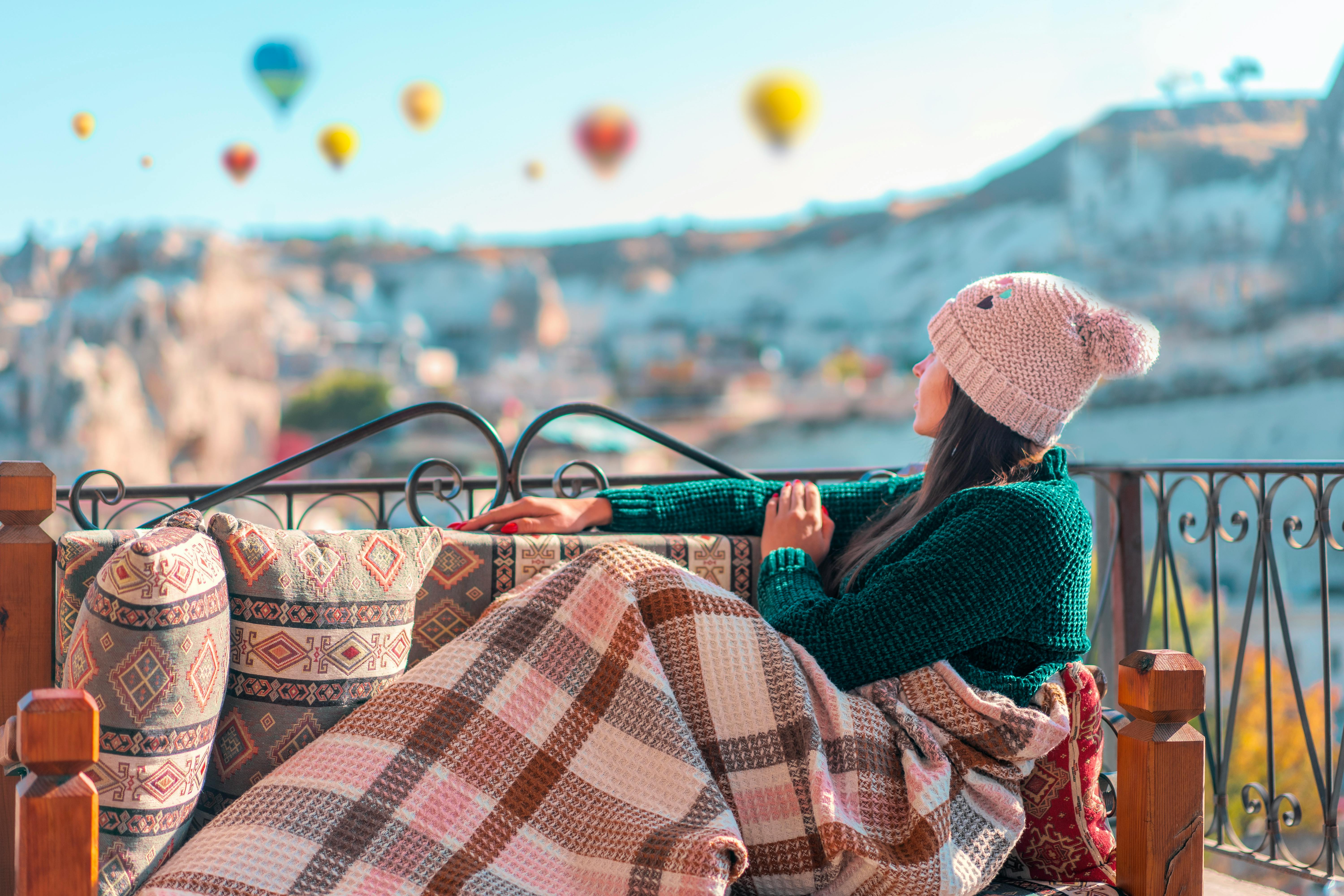 Woman in Green Sweater and Pink Knit Cap Sitting on Brown Wooden Bench ...