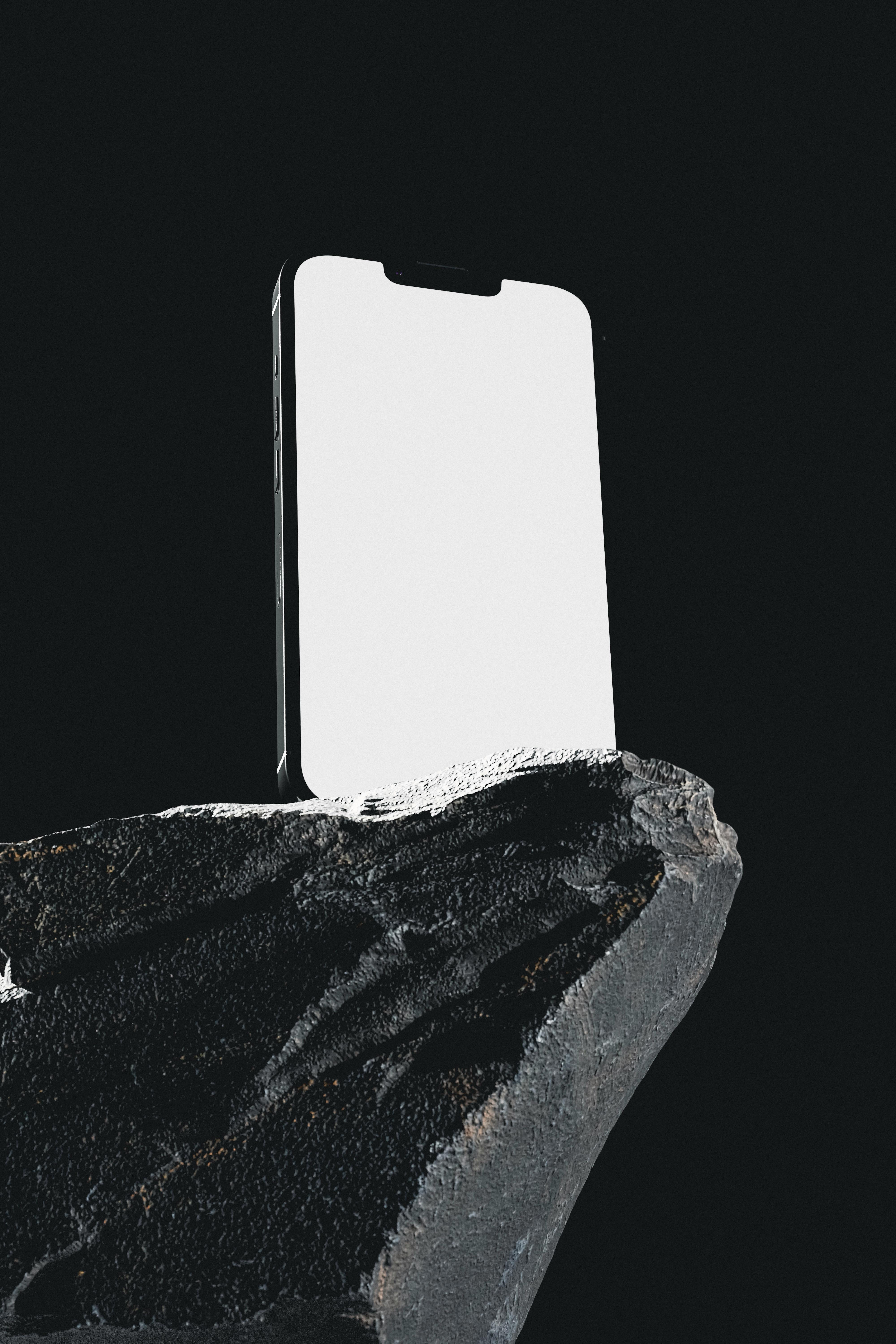 A Grayscale of a Smartphone on a Rock · Free Stock Photo