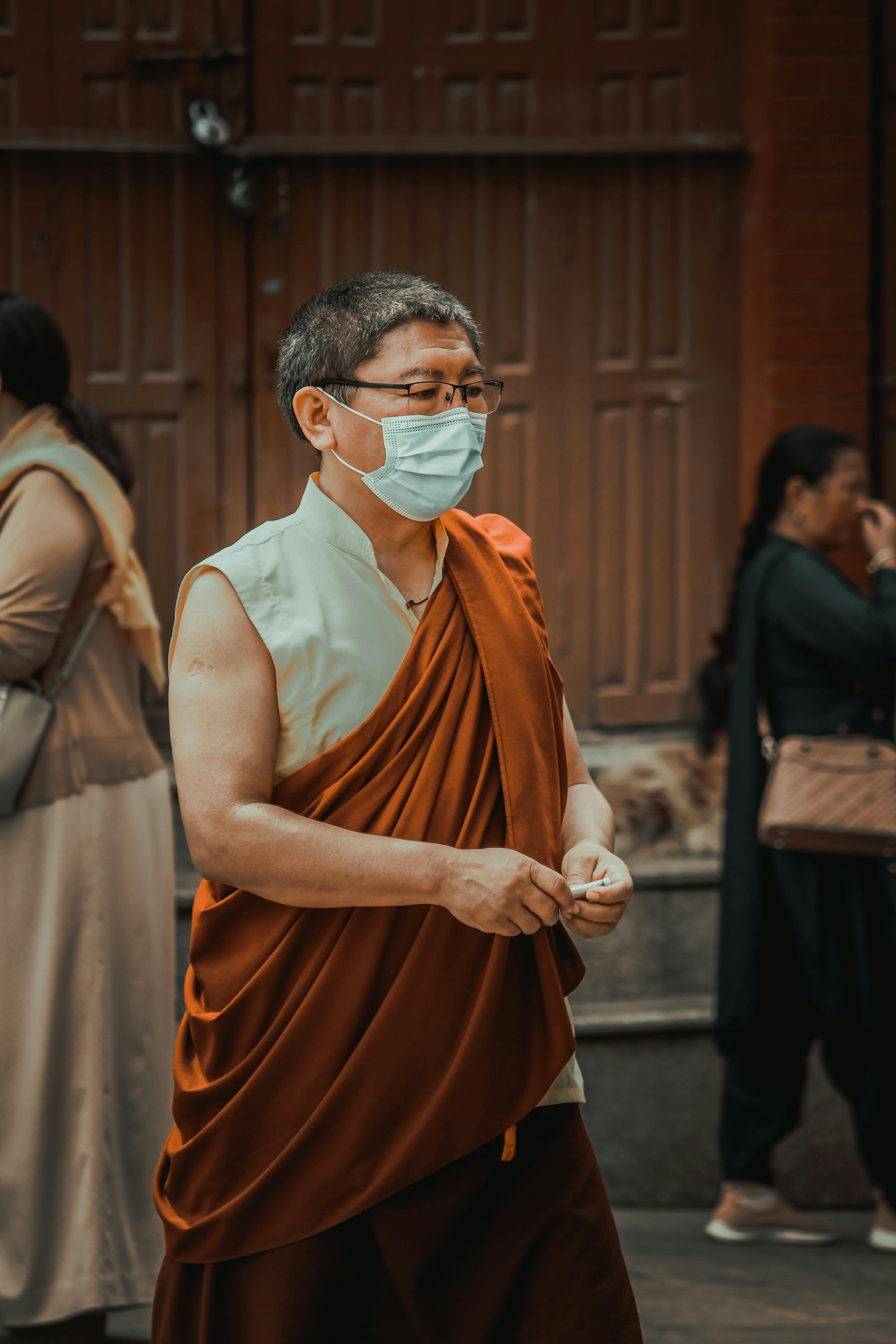 A Monk Wearing a Face mask · Free Stock Photo