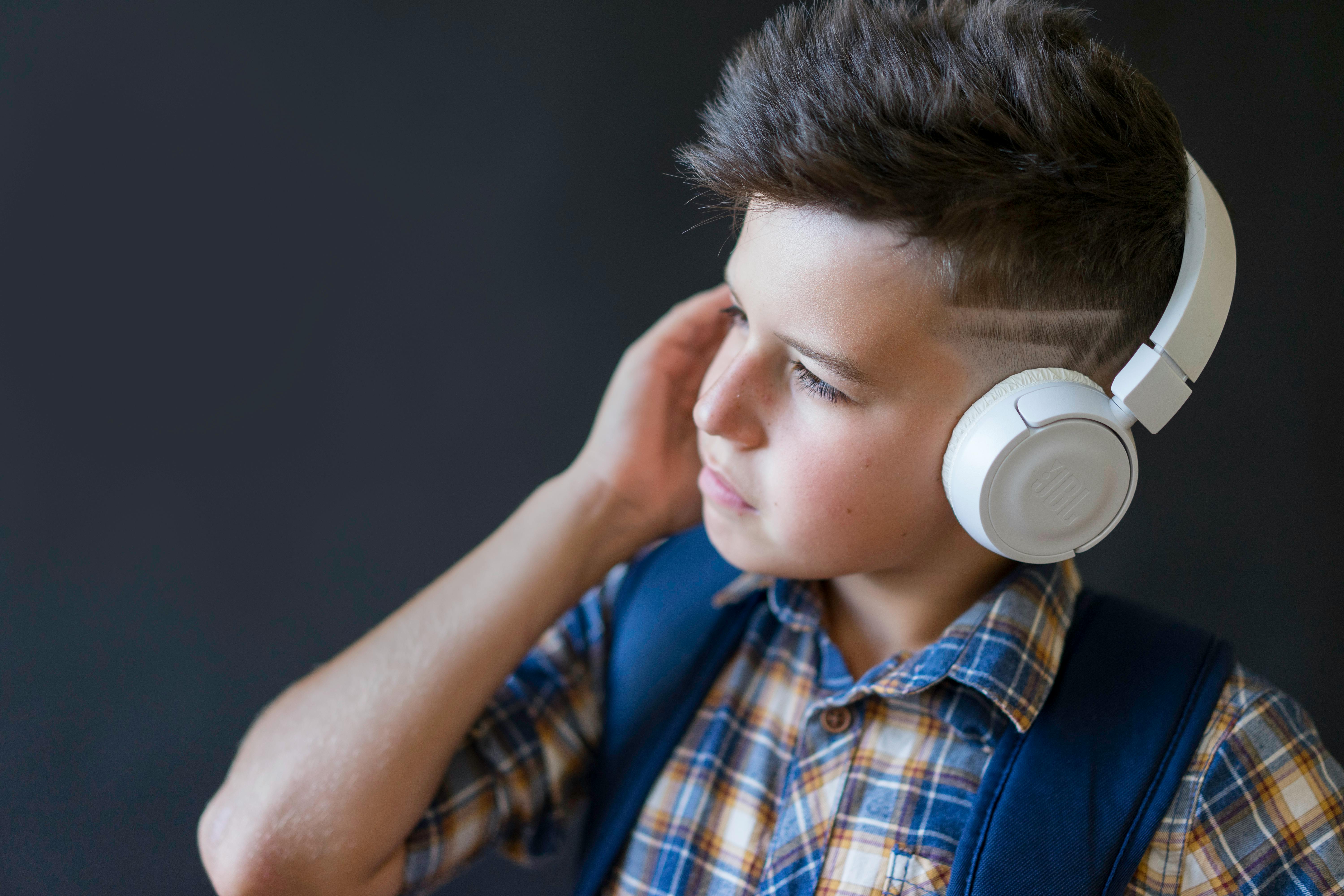 A Boy Wearing Wireless Headphones · Free Stock Photo