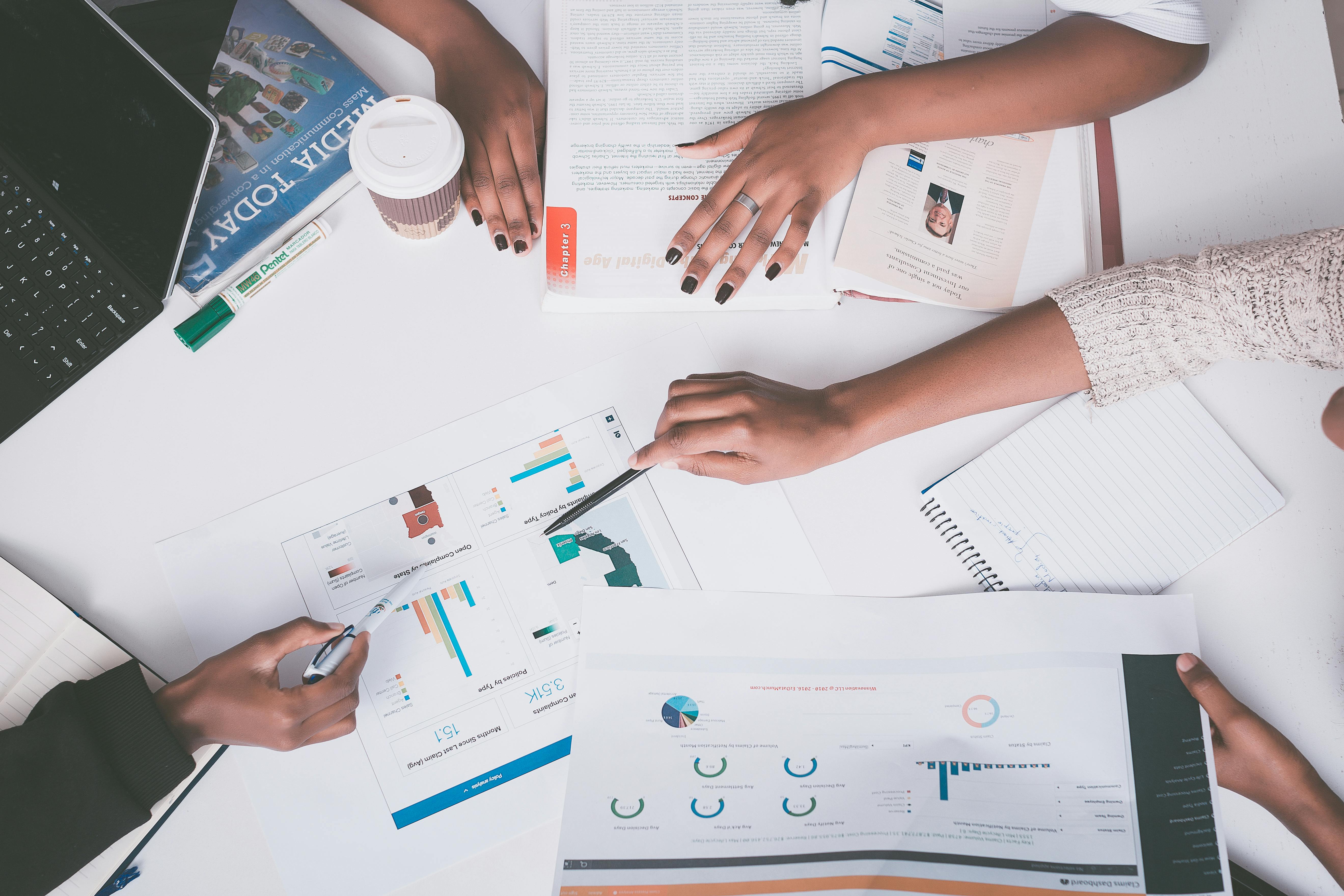 People Looking at a Document · Free Stock Photo