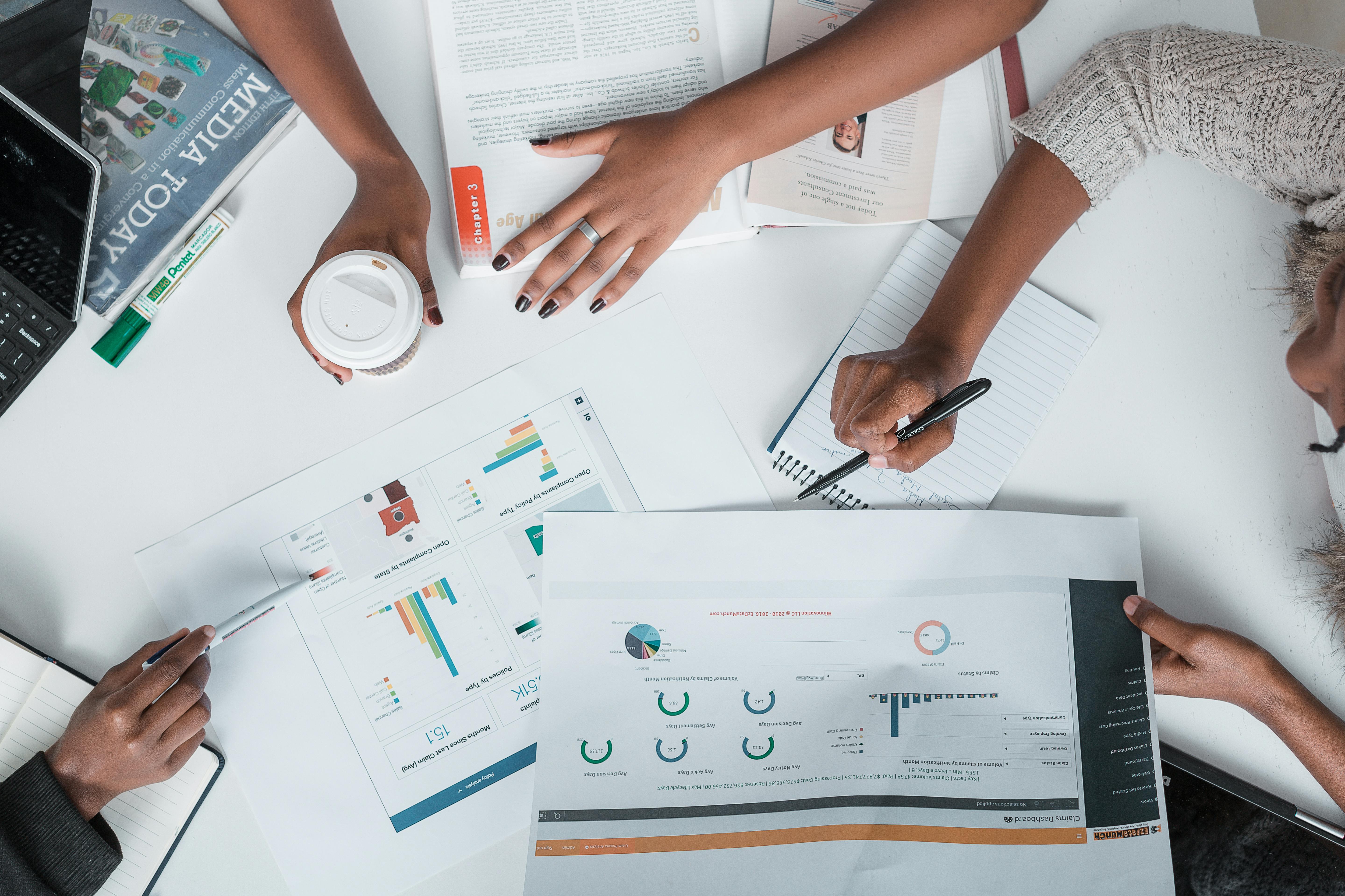 People Looking at a Document · Free Stock Photo