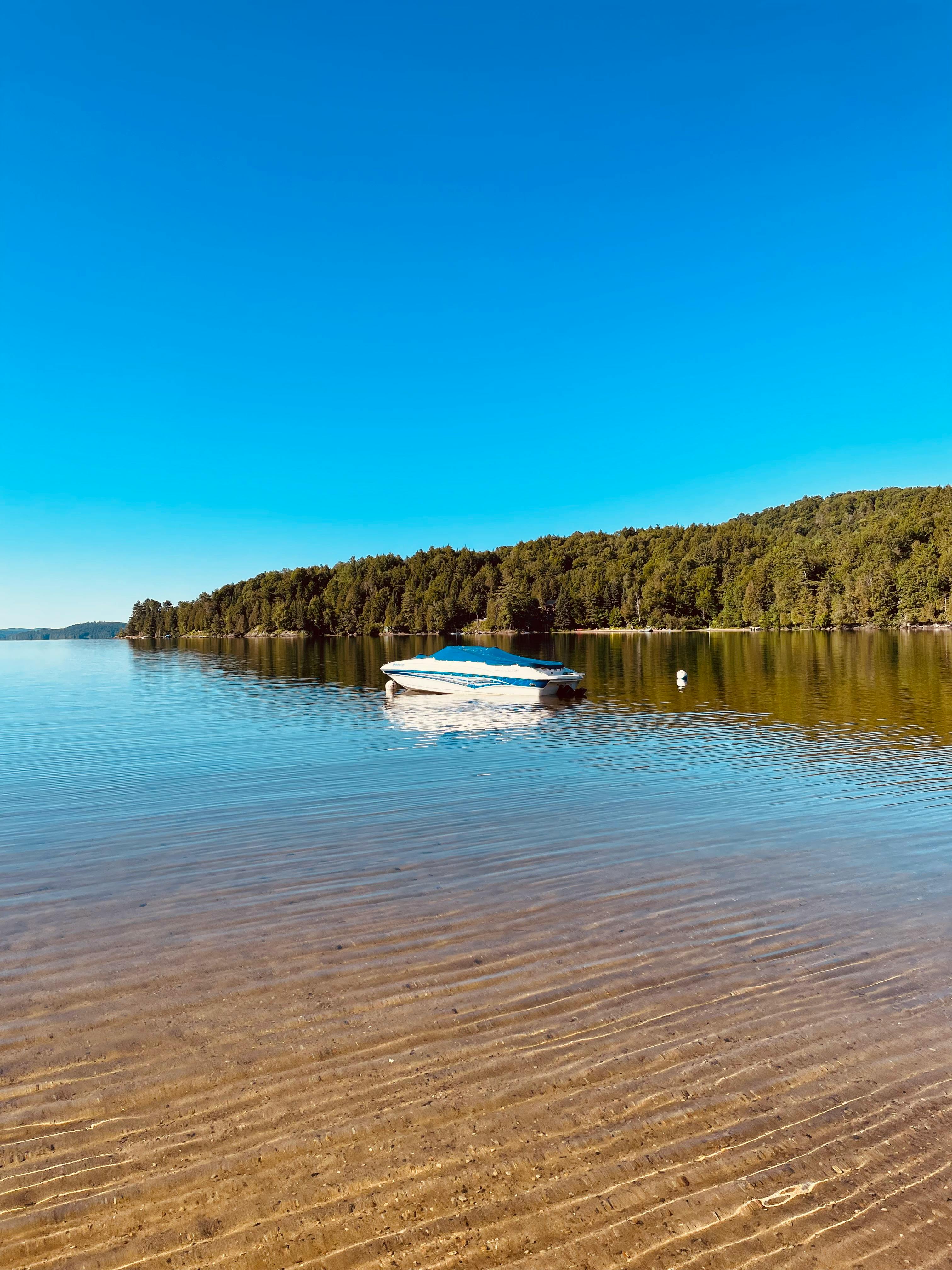 Buoys and a Motorboat Floating on a Lake · Free Stock Photo