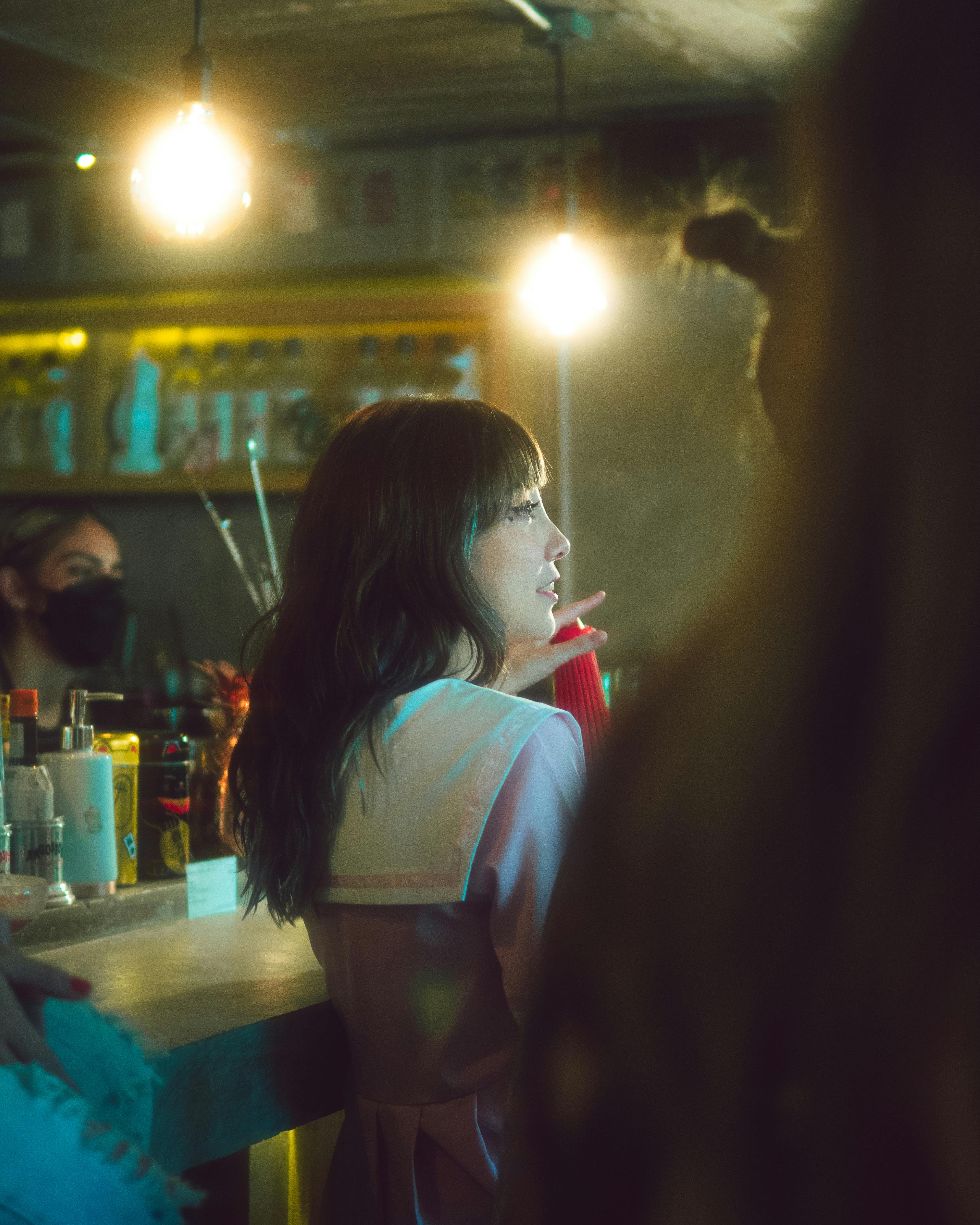 Young Woman Next to a Bar Counter · Free Stock Photo