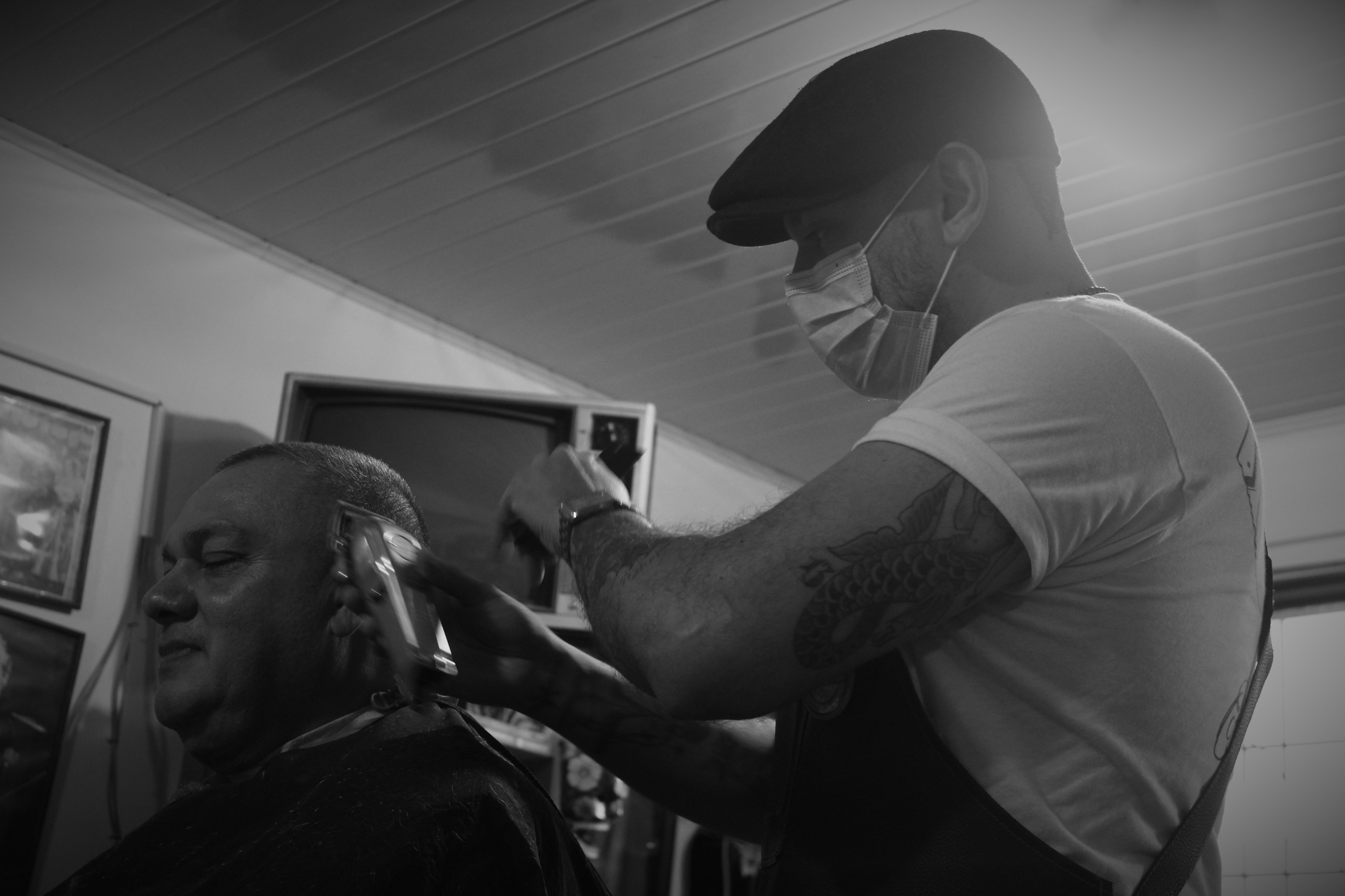 A Grayscale Photo of Man Styling a Guys Hair · Free Stock Photo