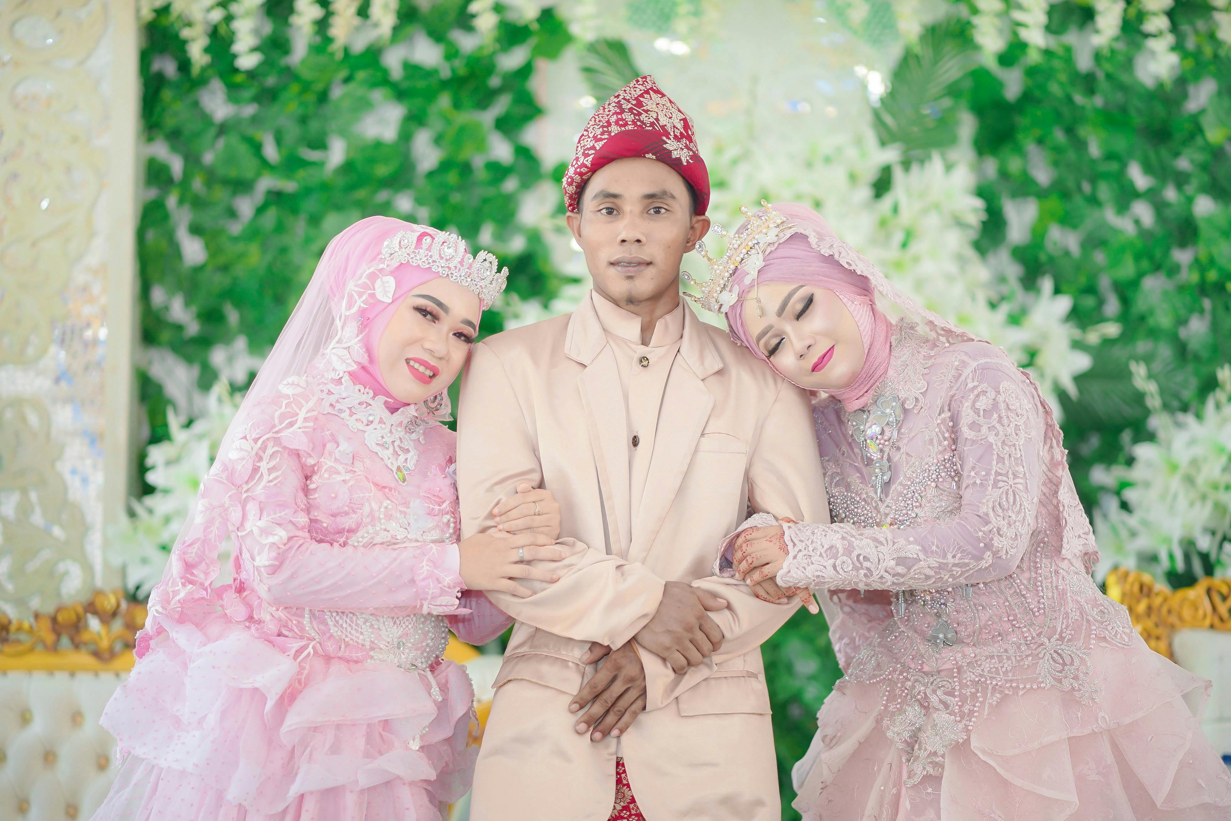 Women Standing by a Man in Traditional Clothing · Free Stock Photo